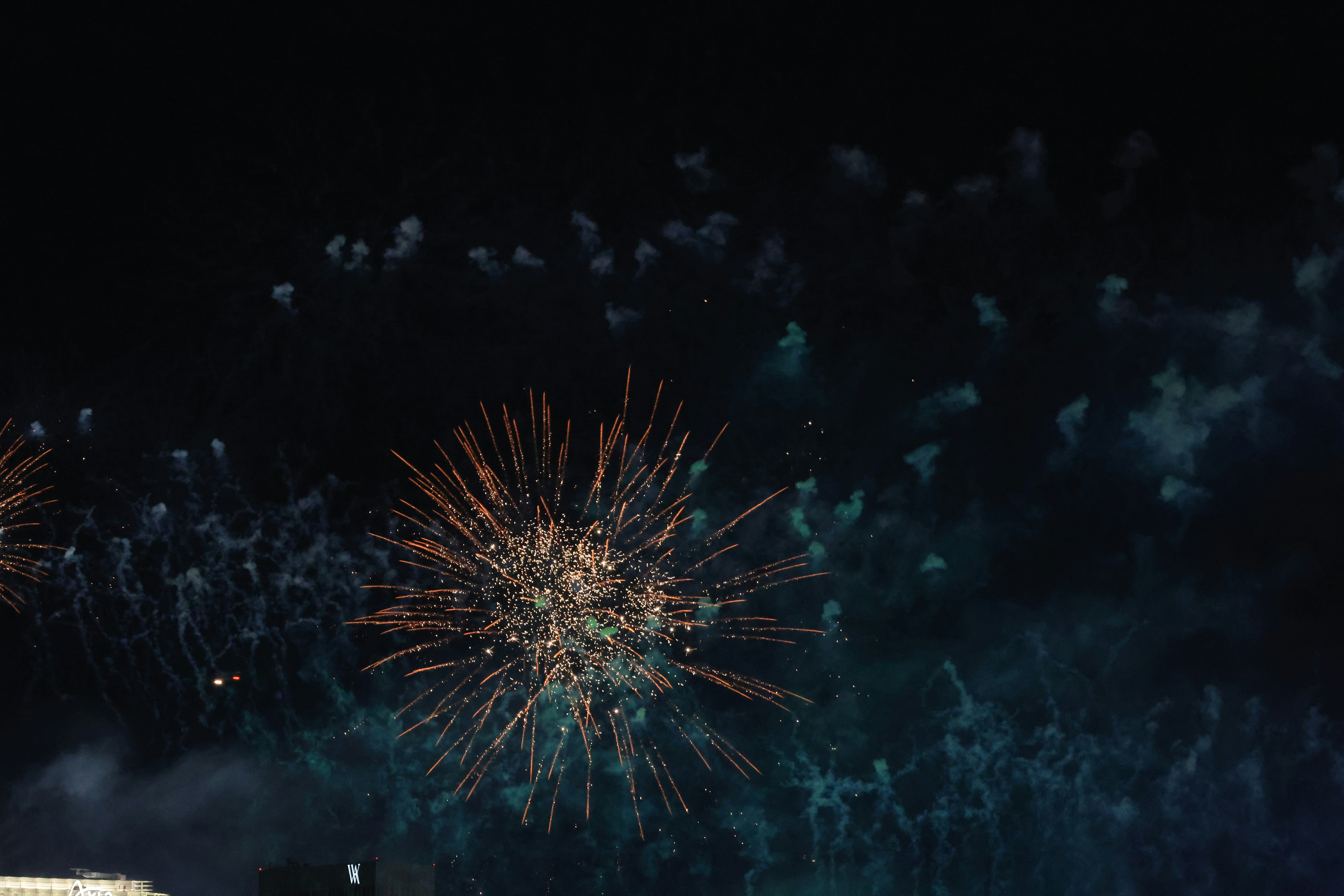 Firework Bloom Over Quiet City Lights