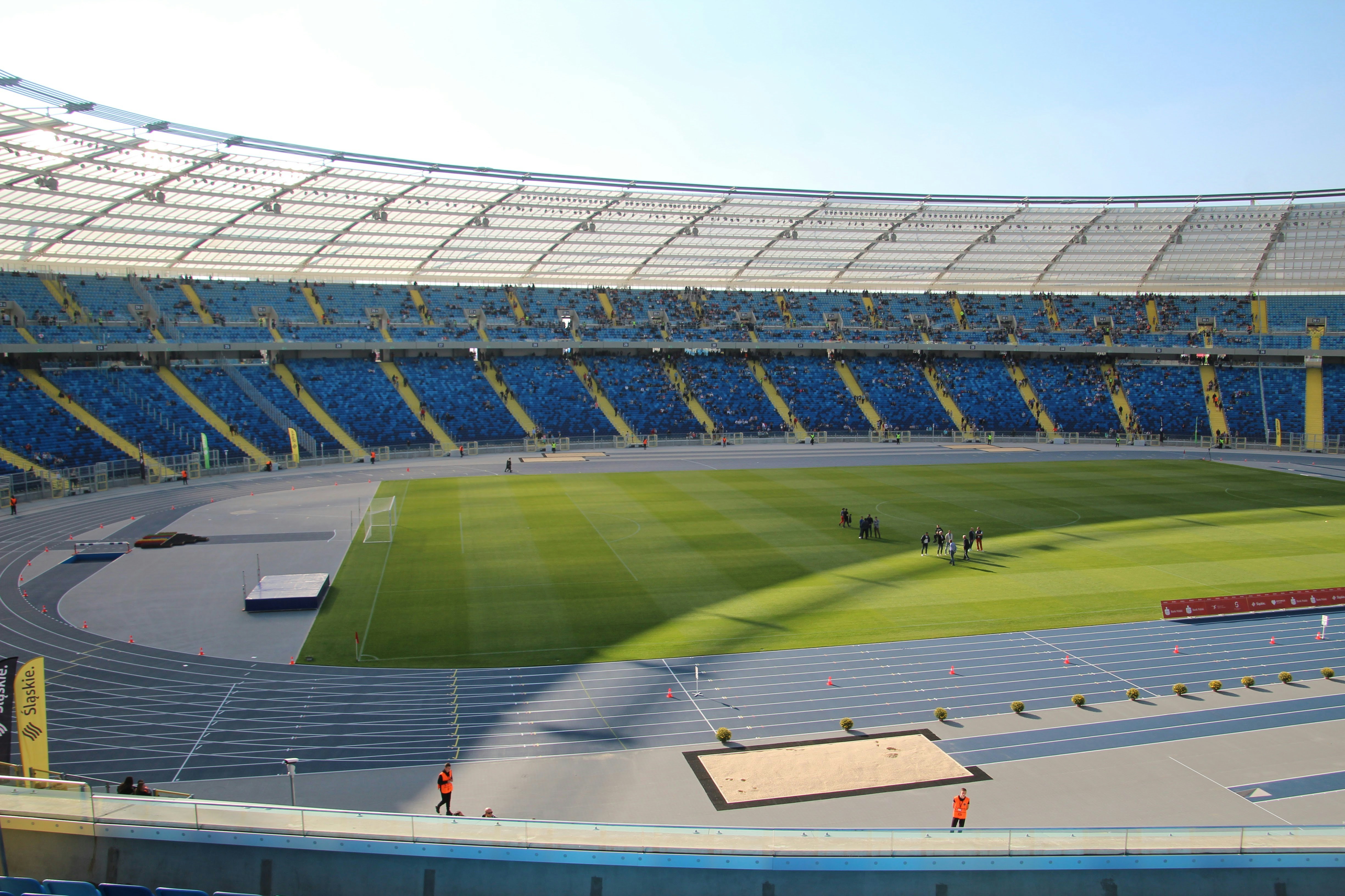 Sunlit Soccer Field in a Quiet Stadium