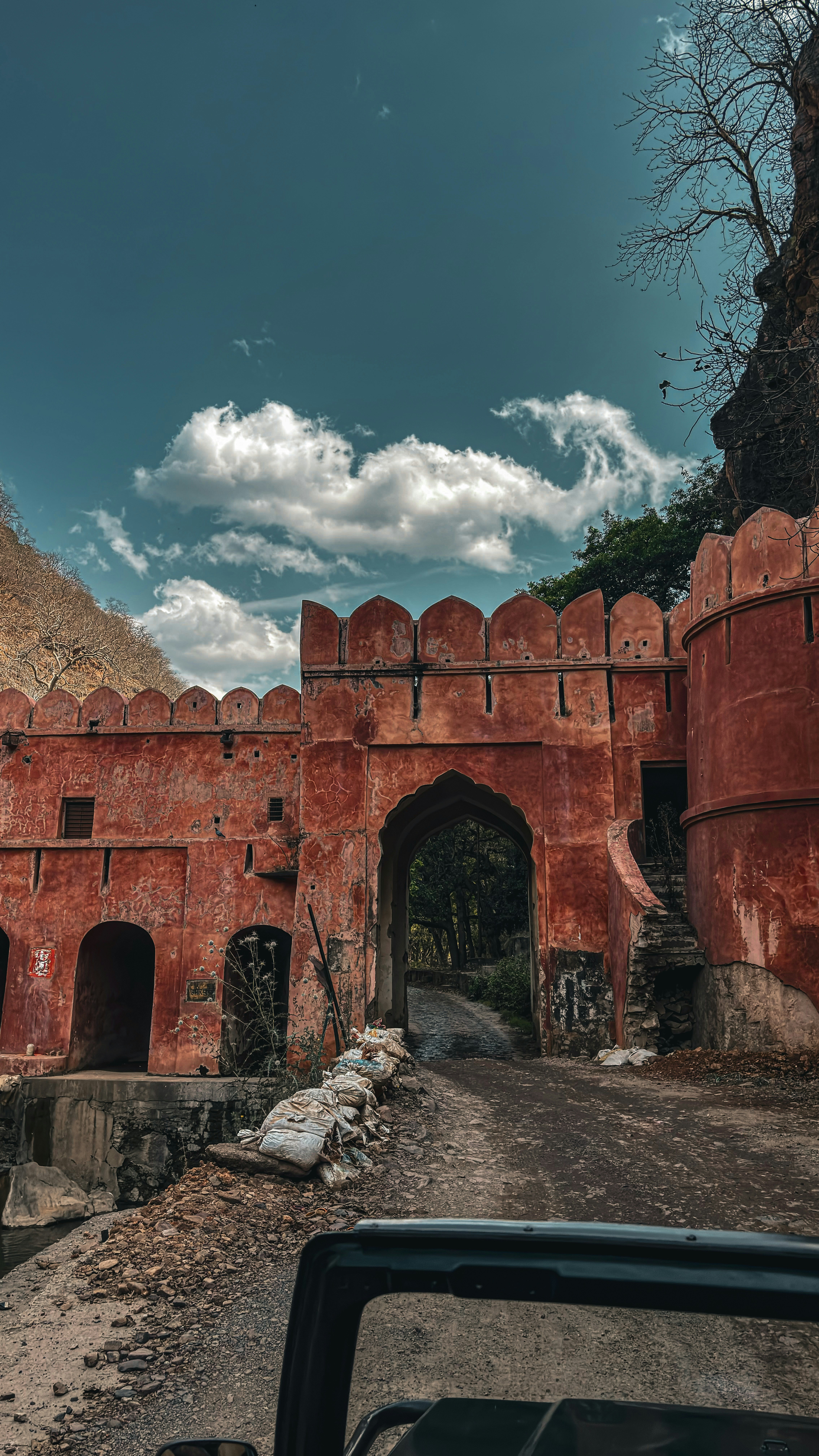 Red Fortress Gate under a Sky of Clouds