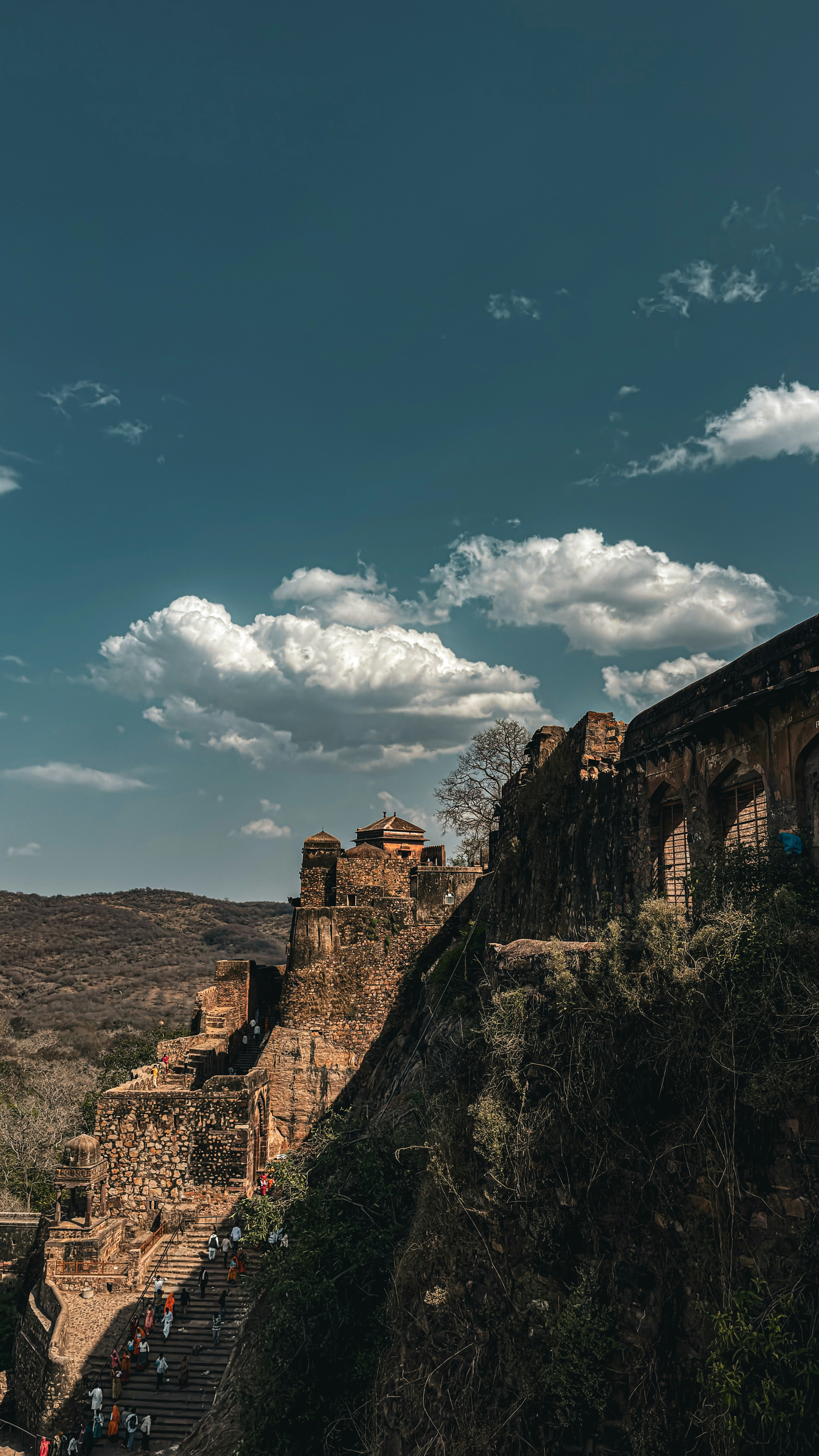 Fortress on the Cliffs: A Sunlit Panorama of Distant Stones