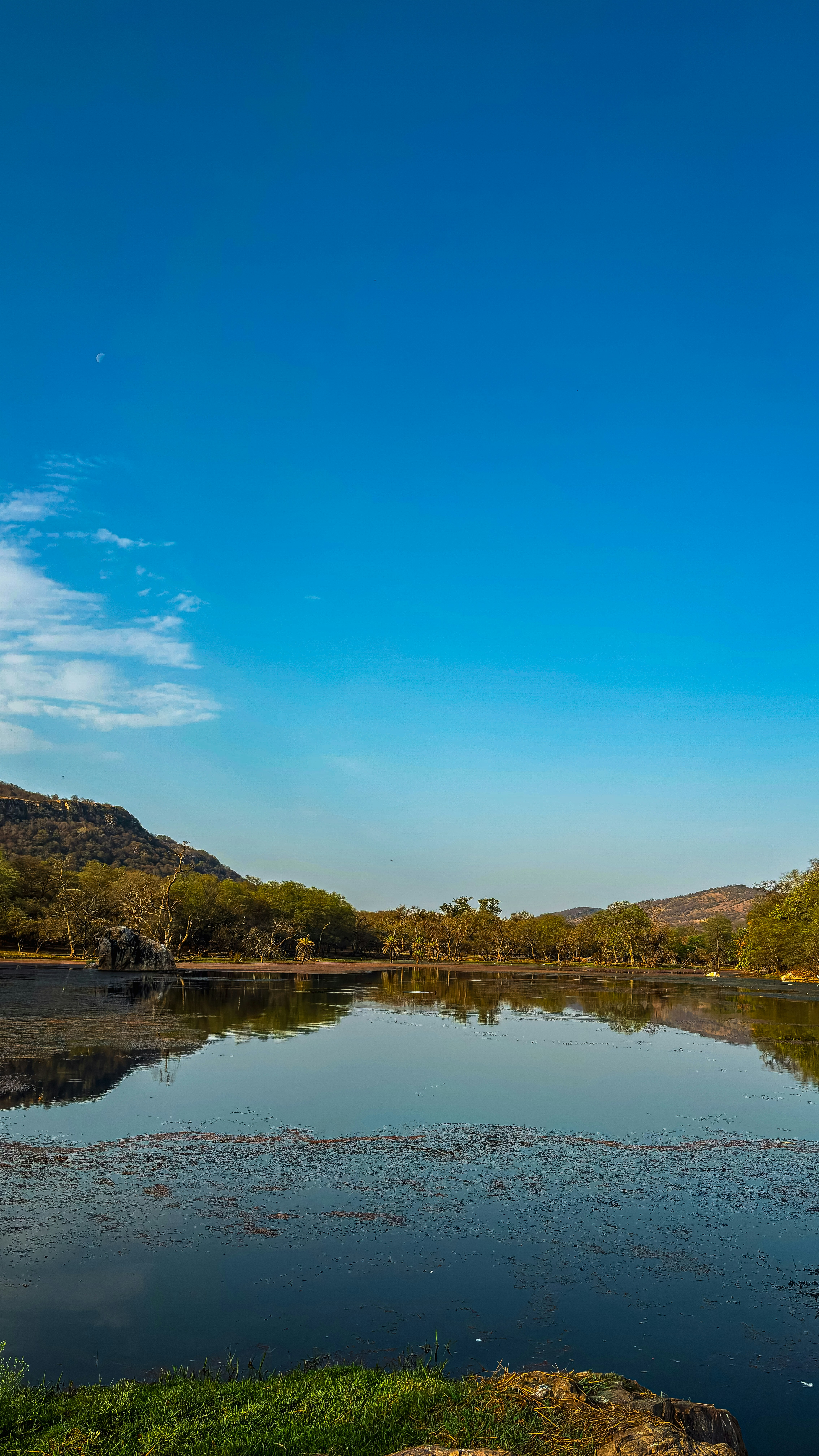 Silent Lake Under a Wide Blue Sky