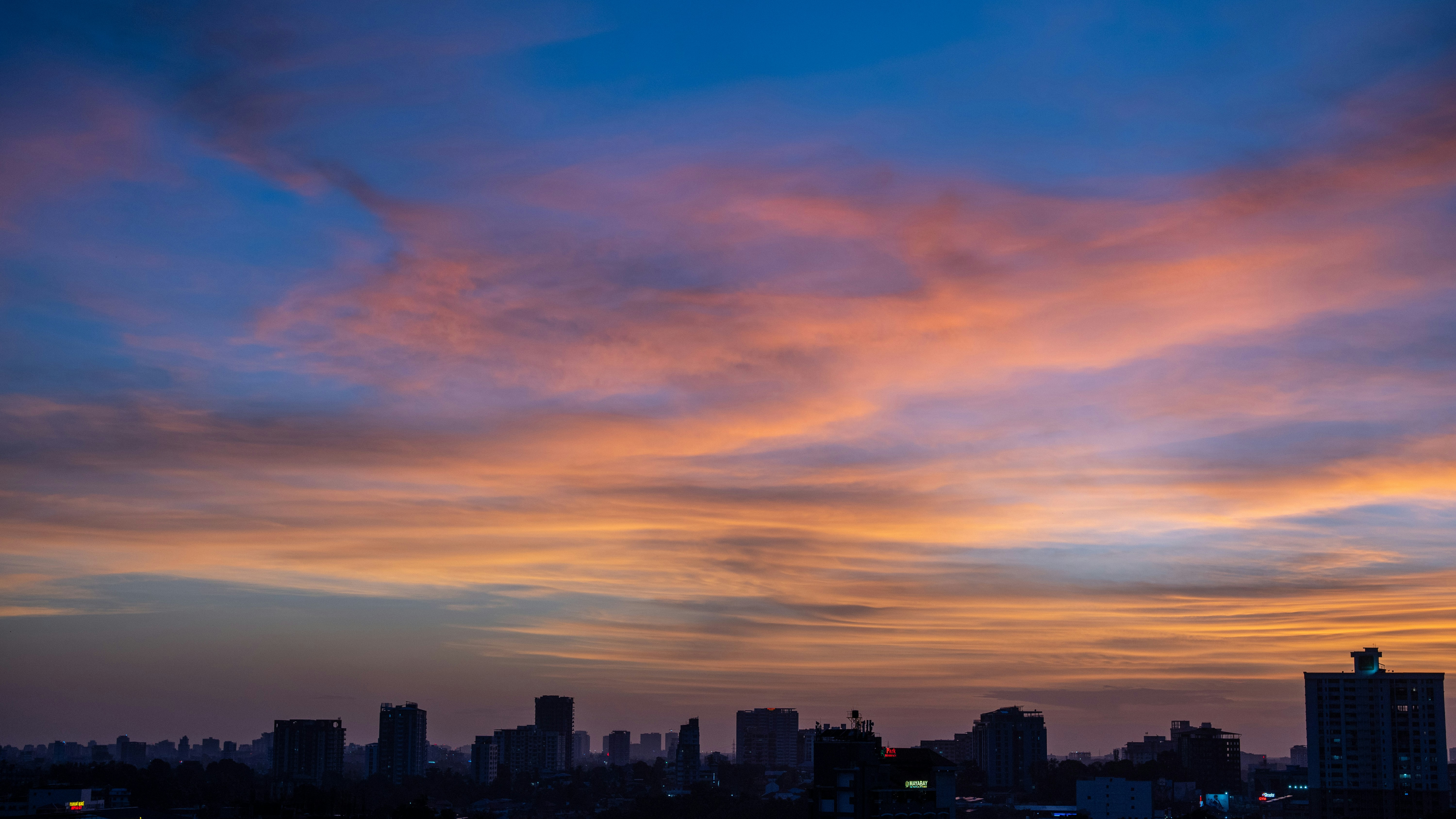 Horizon Fire: City Silhouette Beneath a Dusk-Soaked Sky
