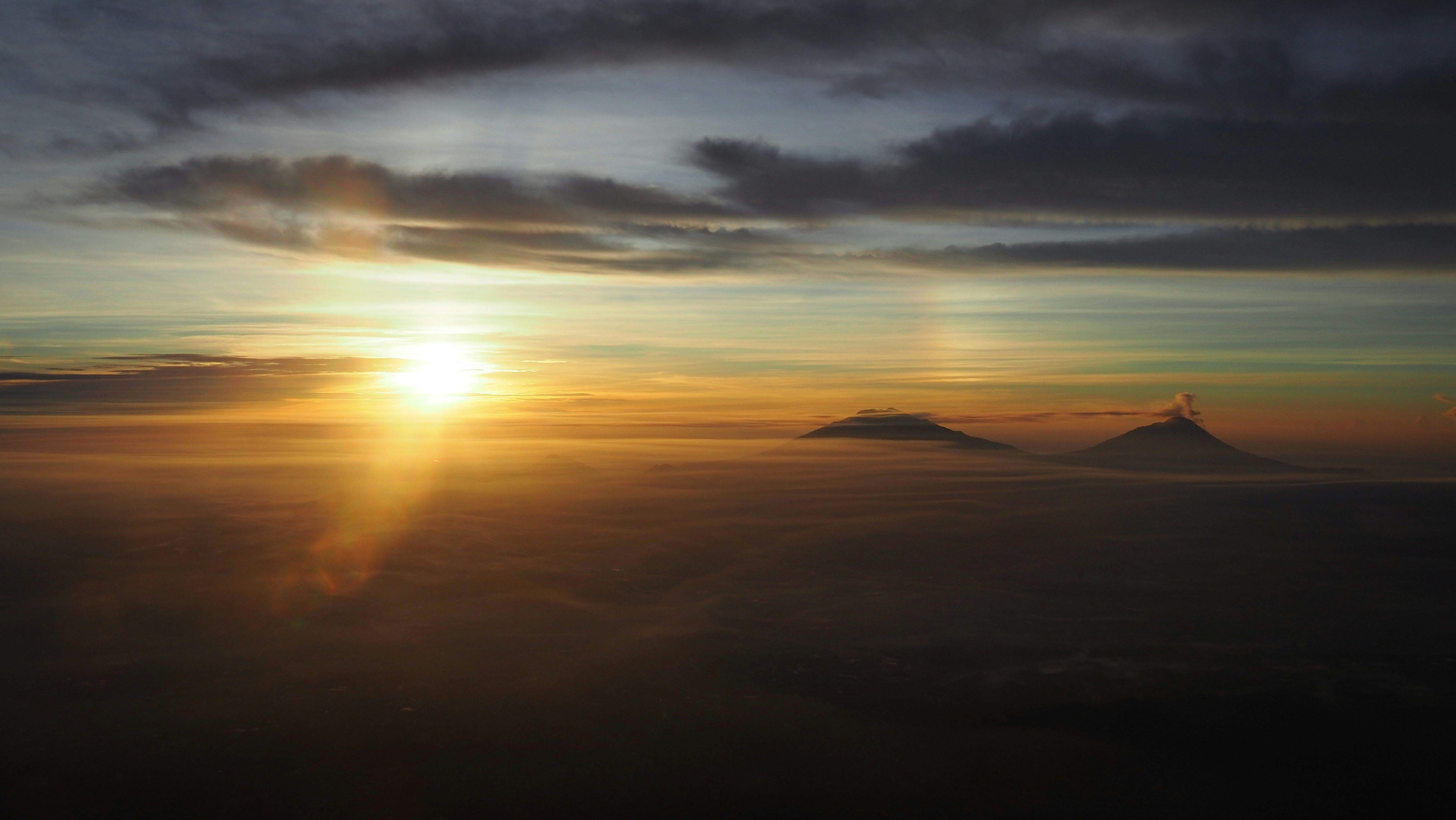Sunlit Ridge: Dawn Over Ocean of Clouds