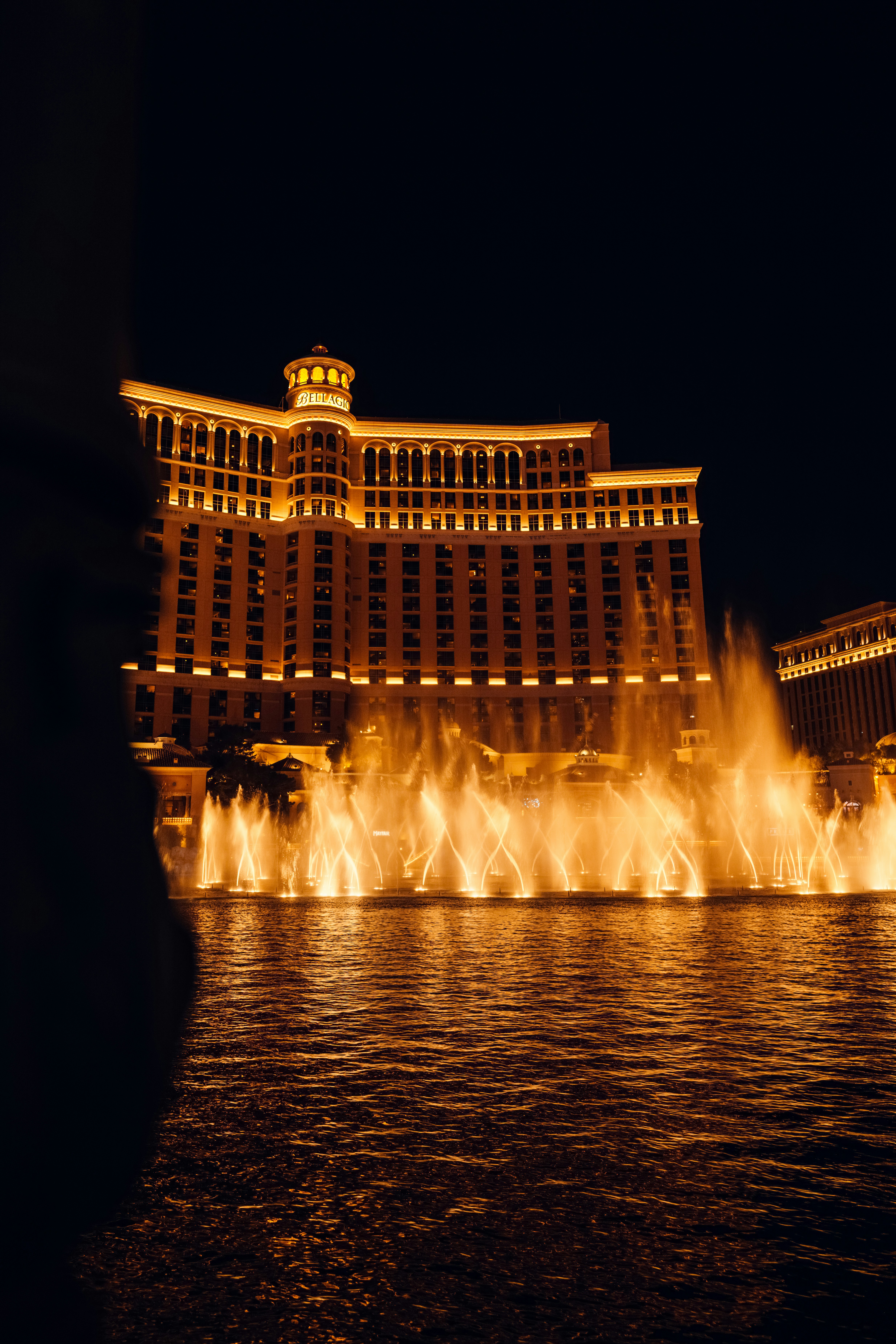 Golden Cascade: Night Fountain Against a Monolithic Hotel