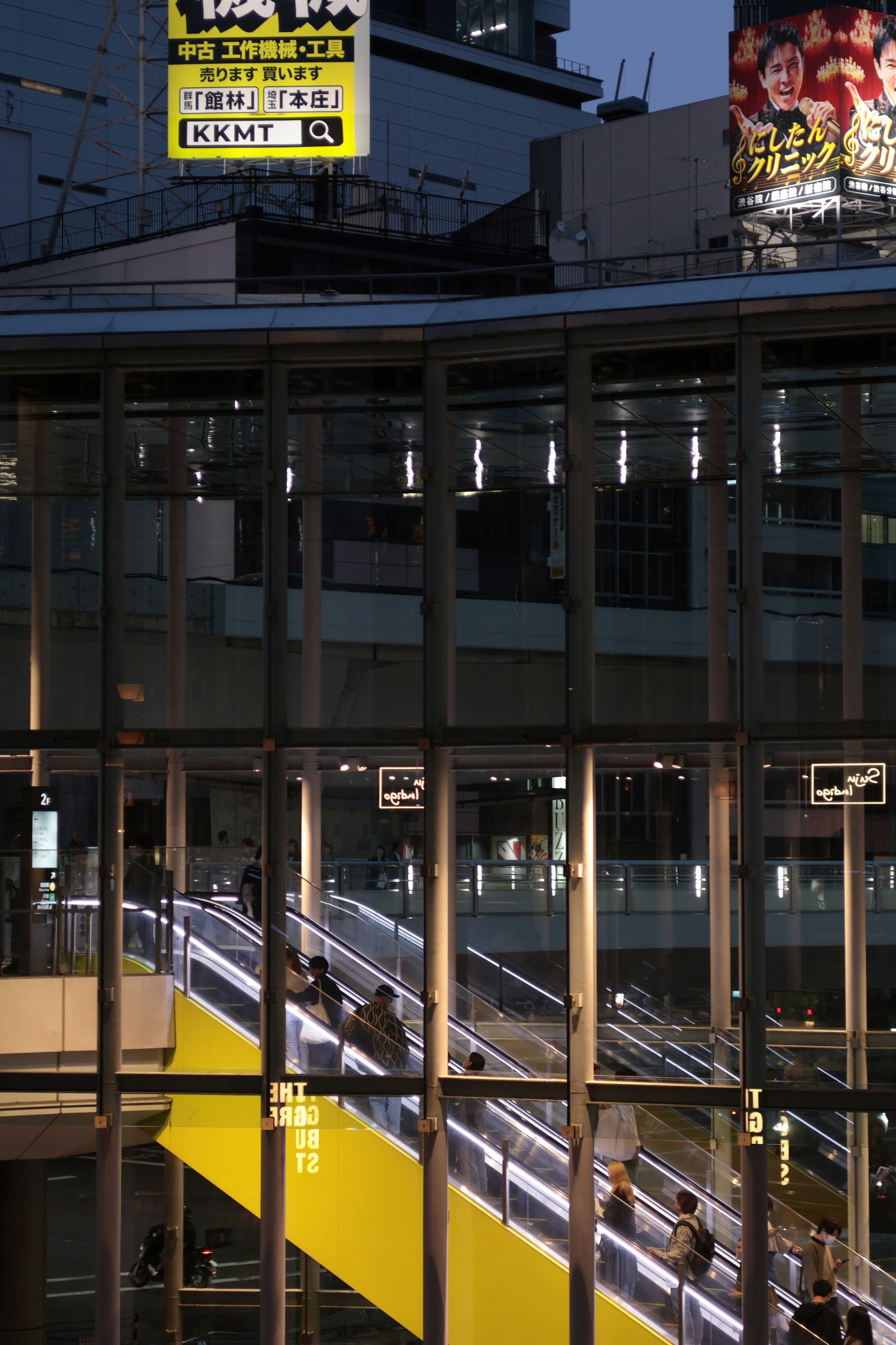 Yellow Ramps and Glass: Nighttime Transit Atrium Reflections