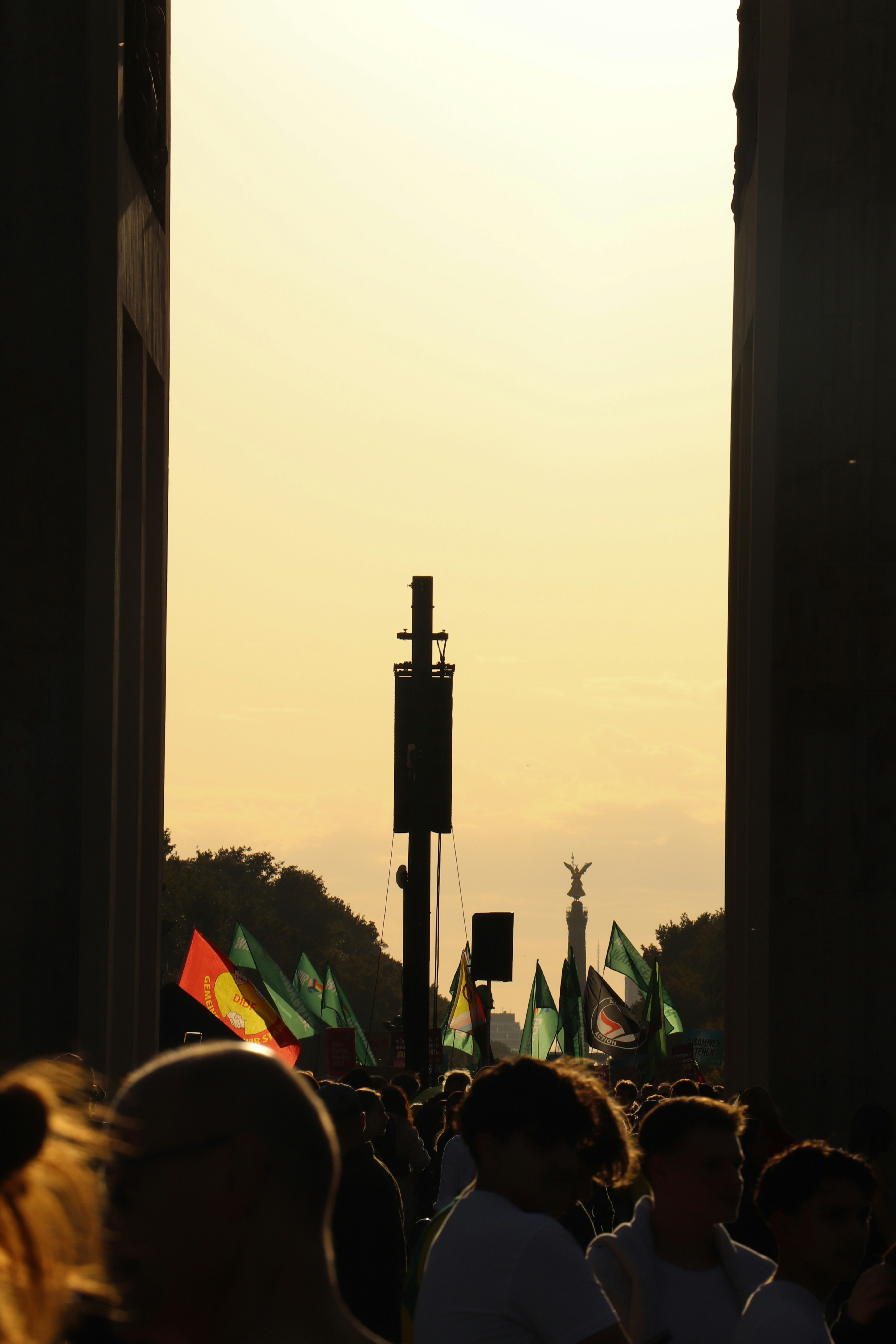 Sunset Through the Gate: A Crowded Moment at a Procession