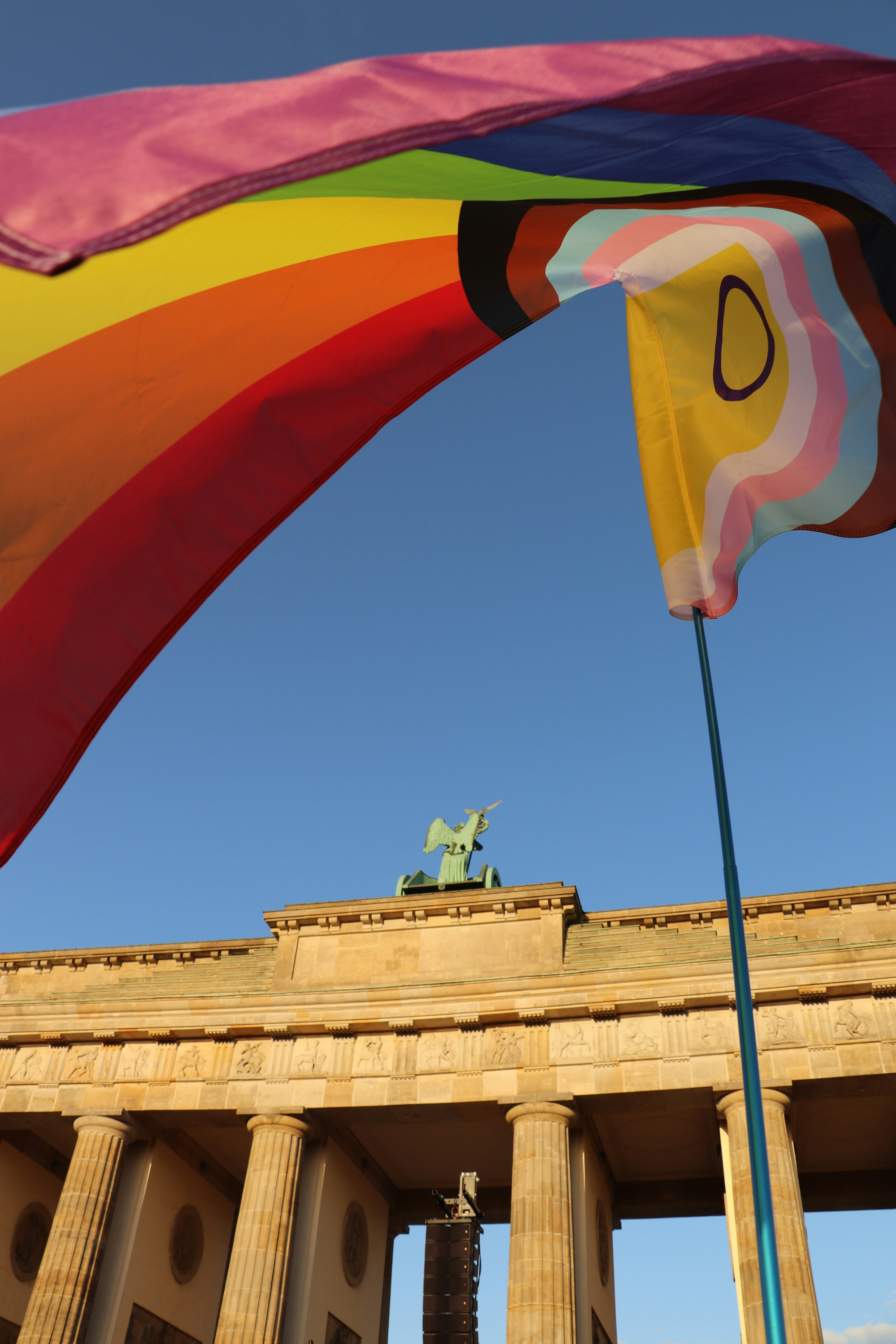 Rainbow Wave Over Pillars: Prism Flag at Civilizational Arch