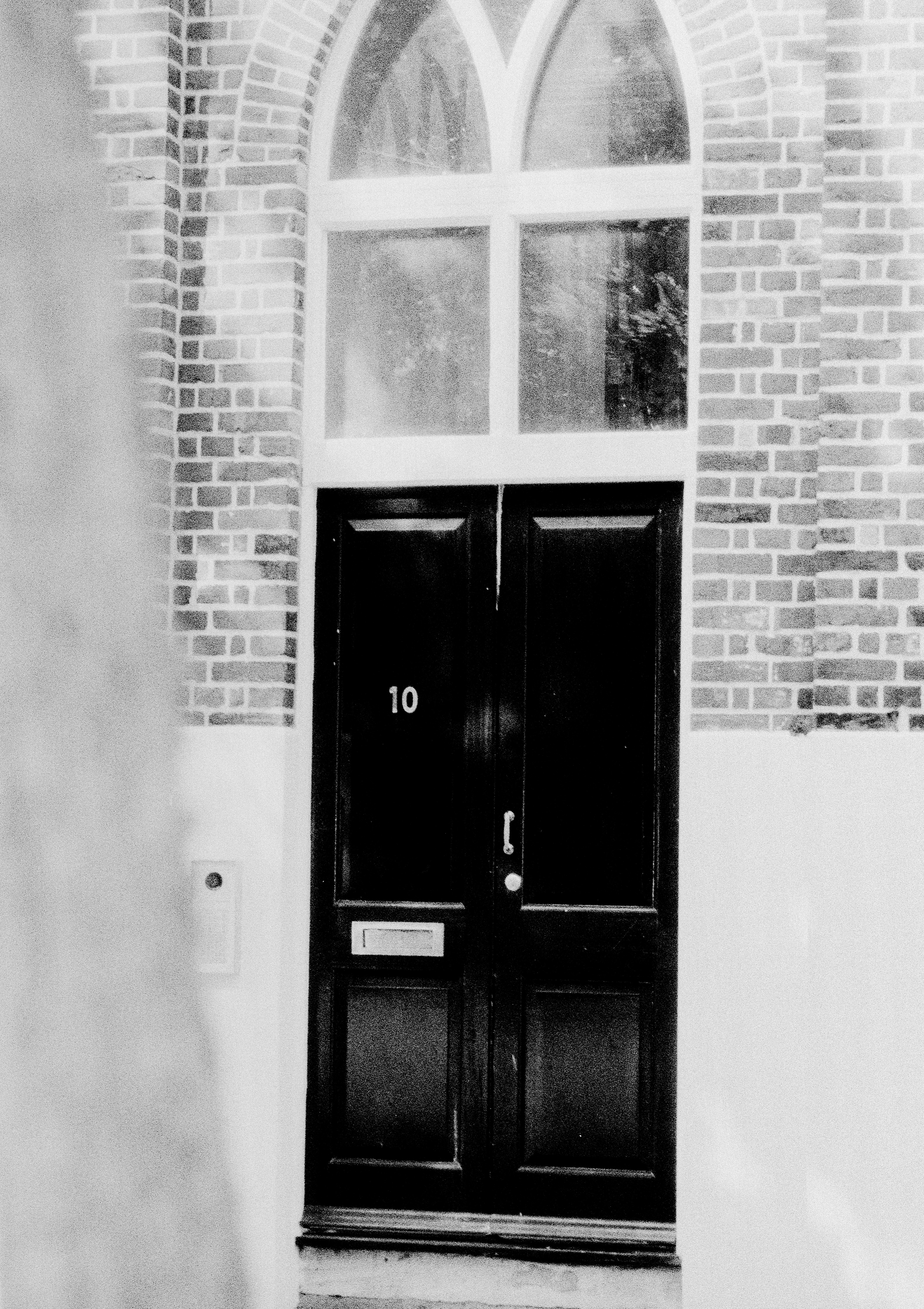 Doorway in the Brick Arch: A Quiet Street Portrait