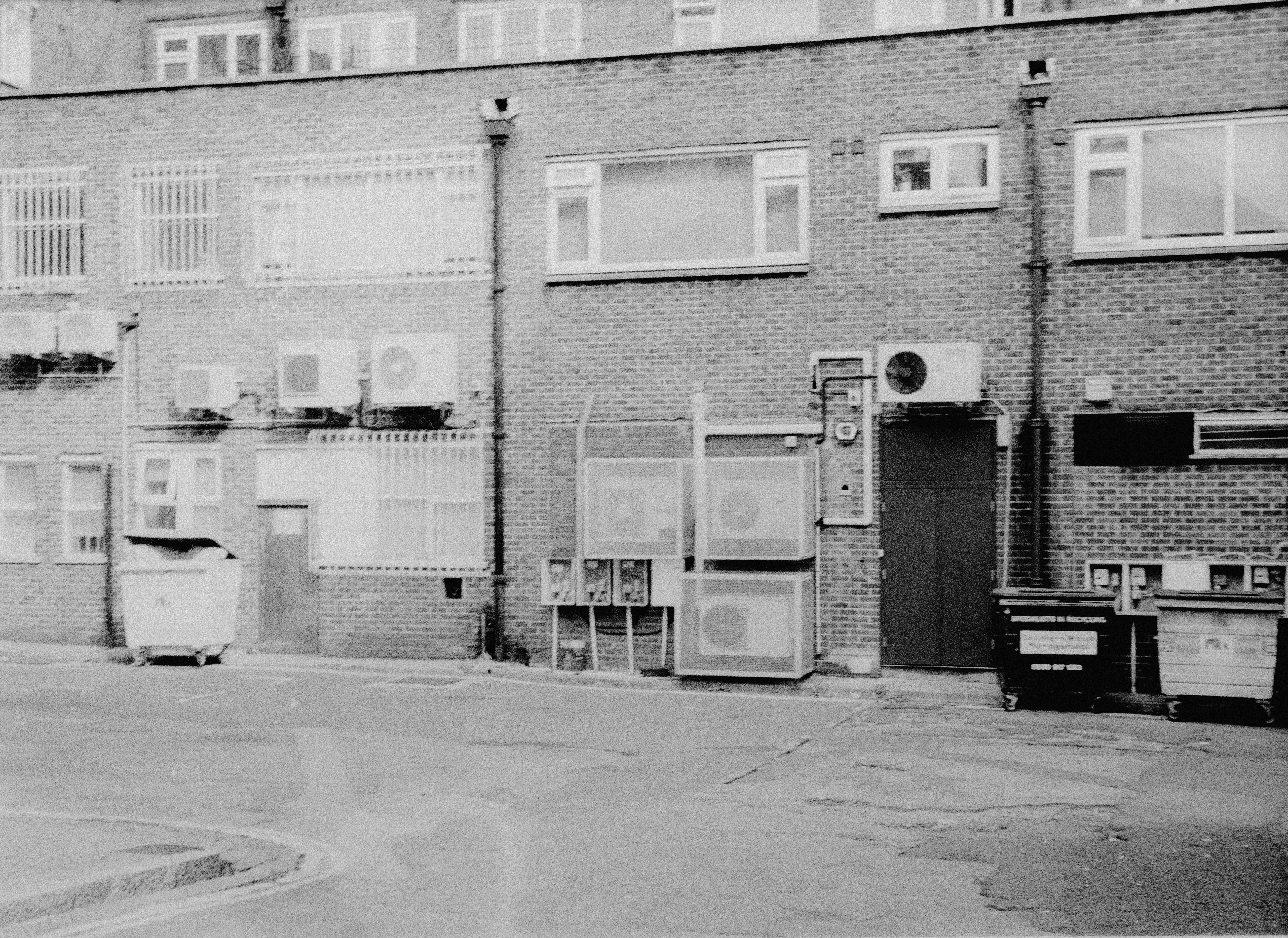 Urban Backstage: A Quiet Courtyard of Wall-Mounted A/C Units