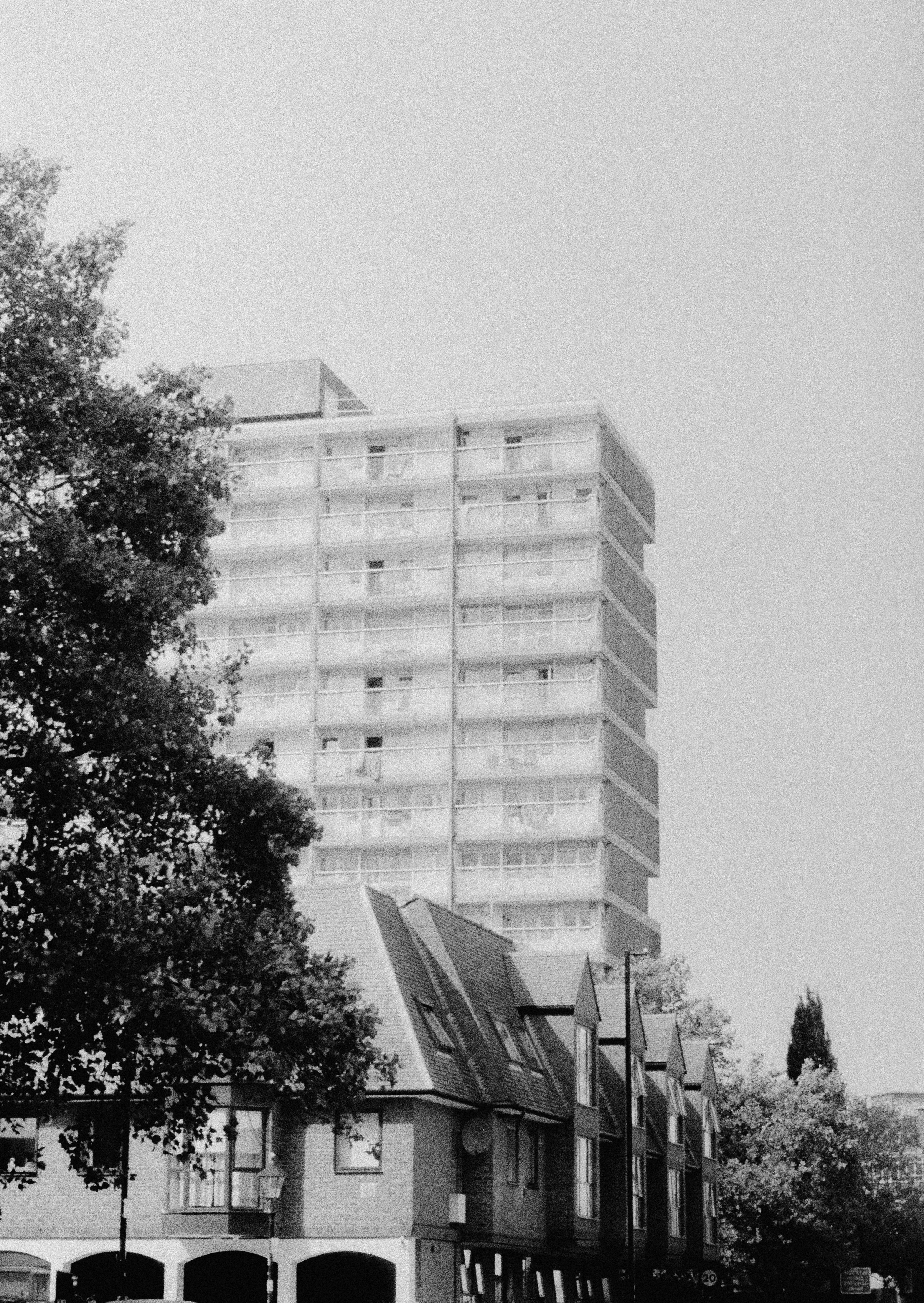 Urban Echoes: A Towered Block Rising Above Ground-Level Homes