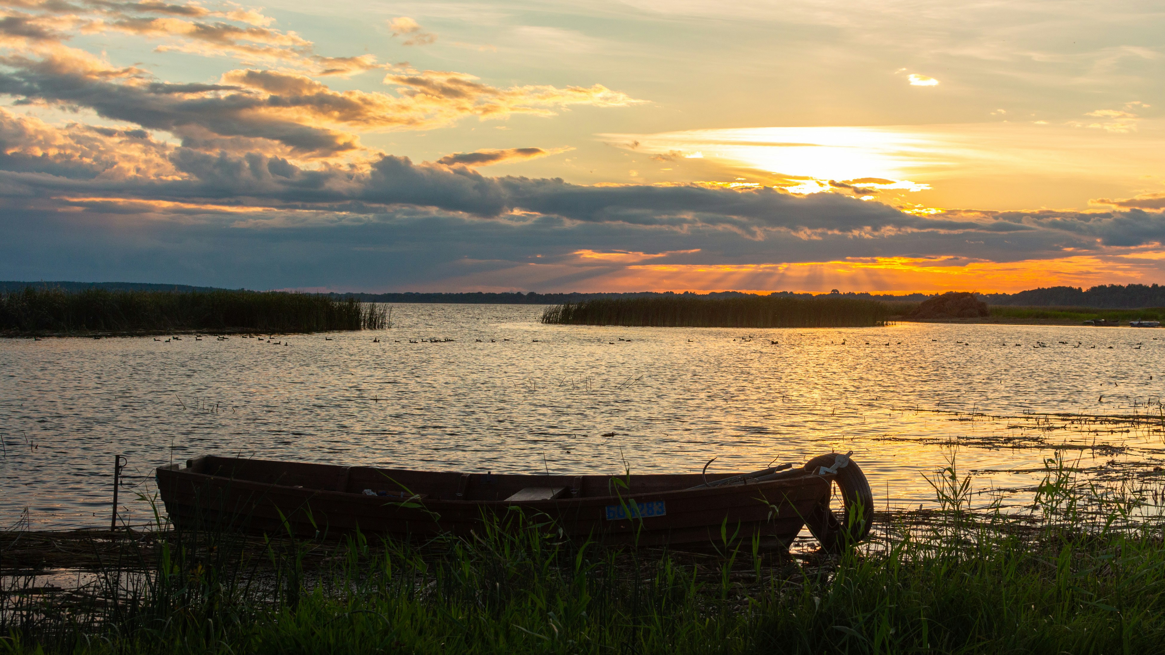 Sunset over a Silent Boat: A Quiet Echo on the Water
