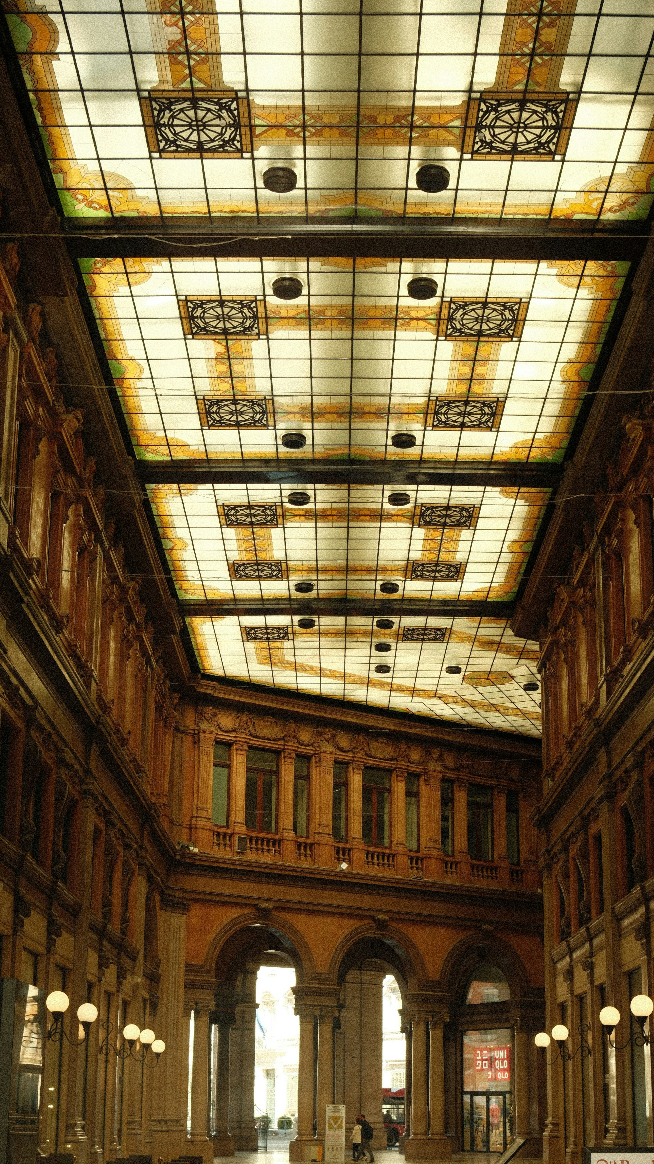 Glass-ceilinged Grand Hall: Classical Arches Beneath a Geometric Skylight