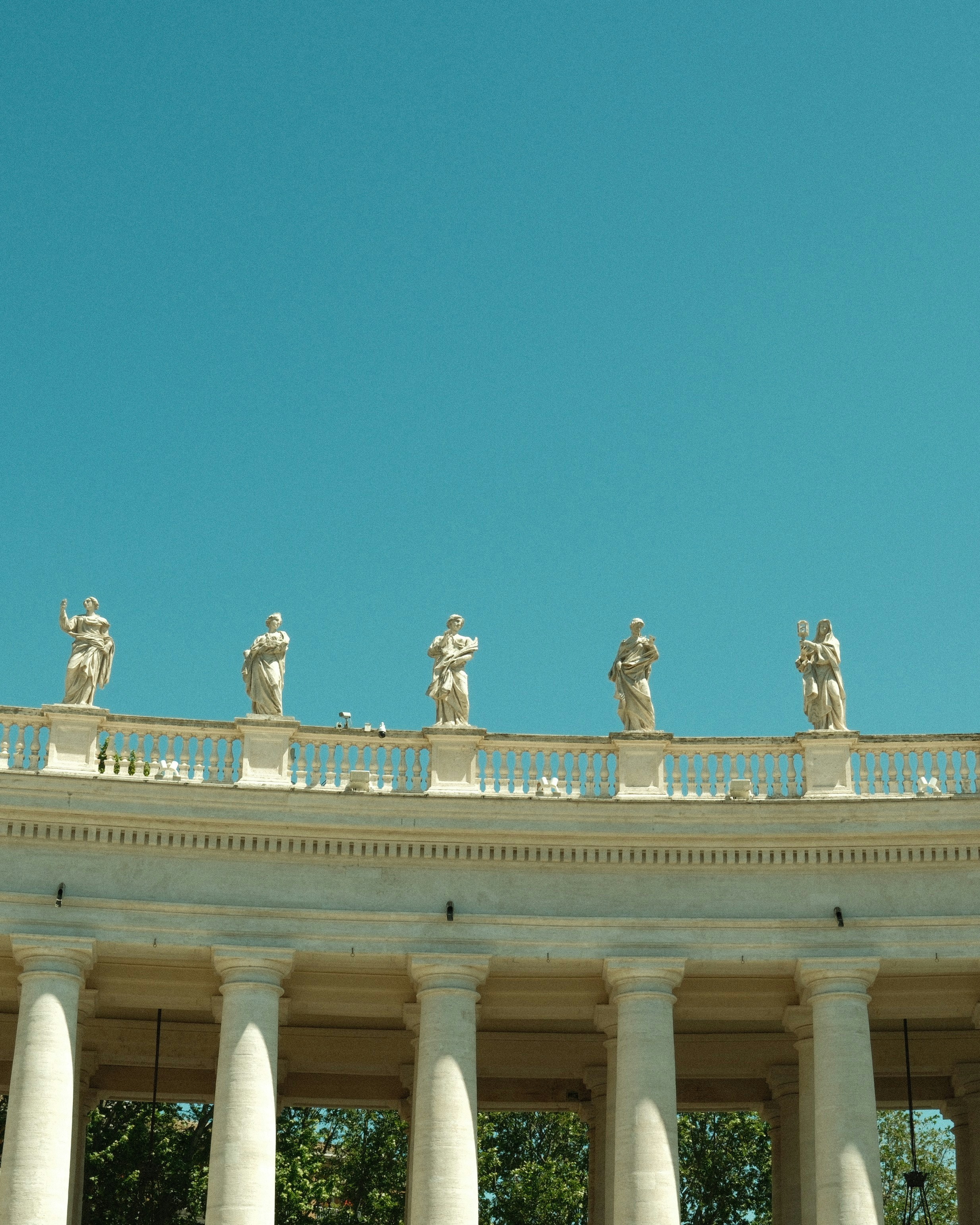 Statues Above the Colonnade: A Row of Noble Figures Guarding the Sky