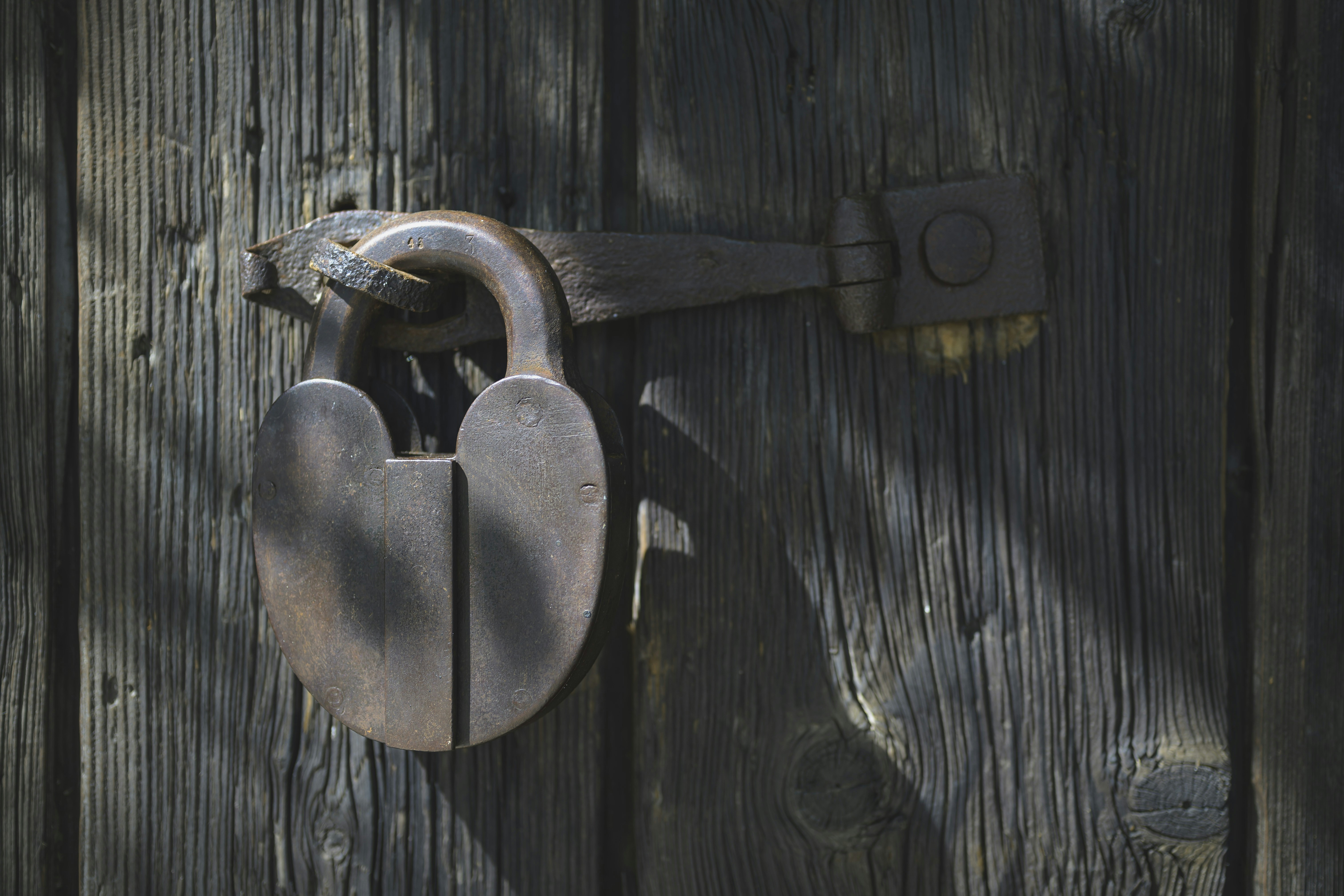 Weathered Heart: A Padlock on a Barn Door