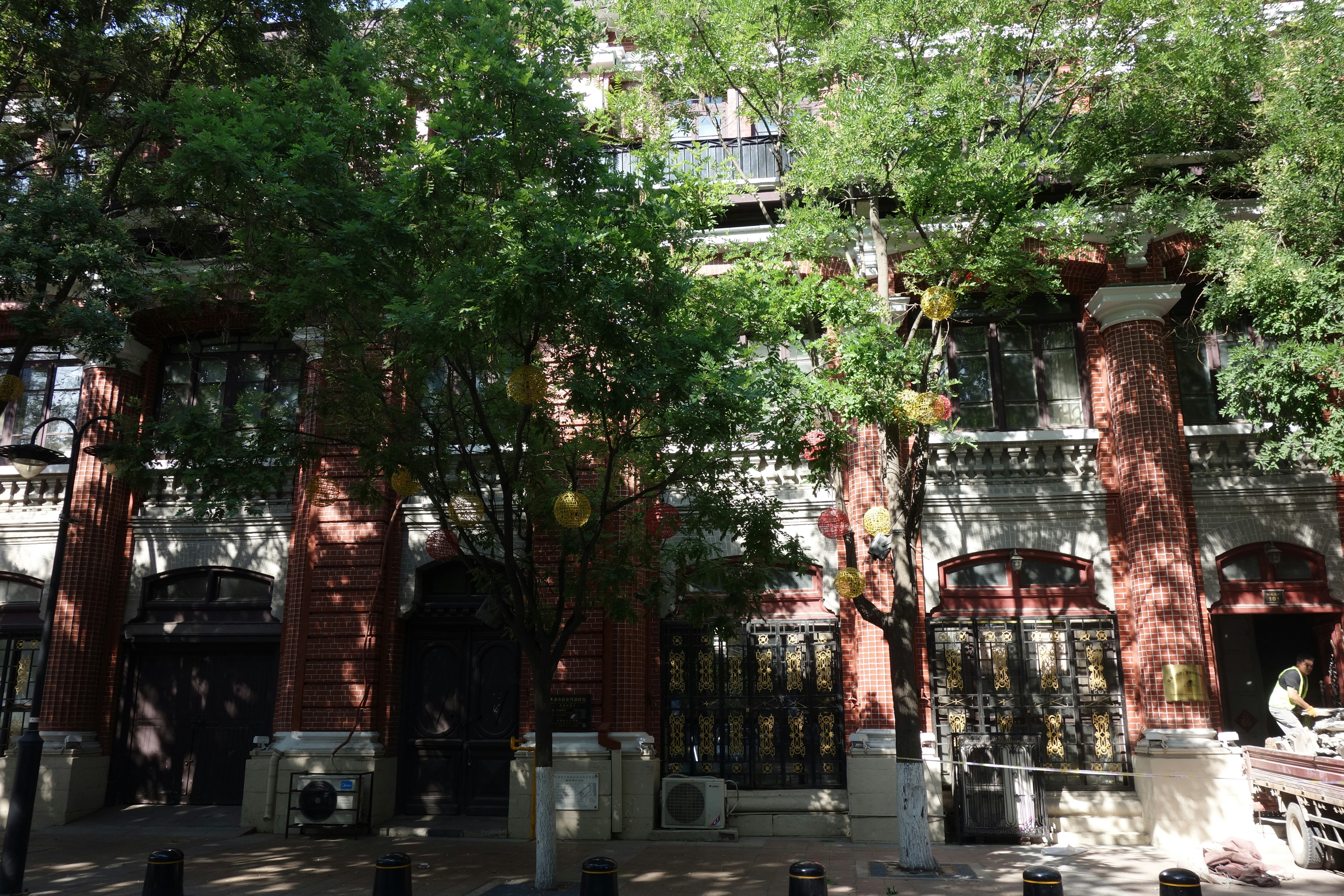 Brick Facade and Tree-dappled Archways by a Quiet Street
