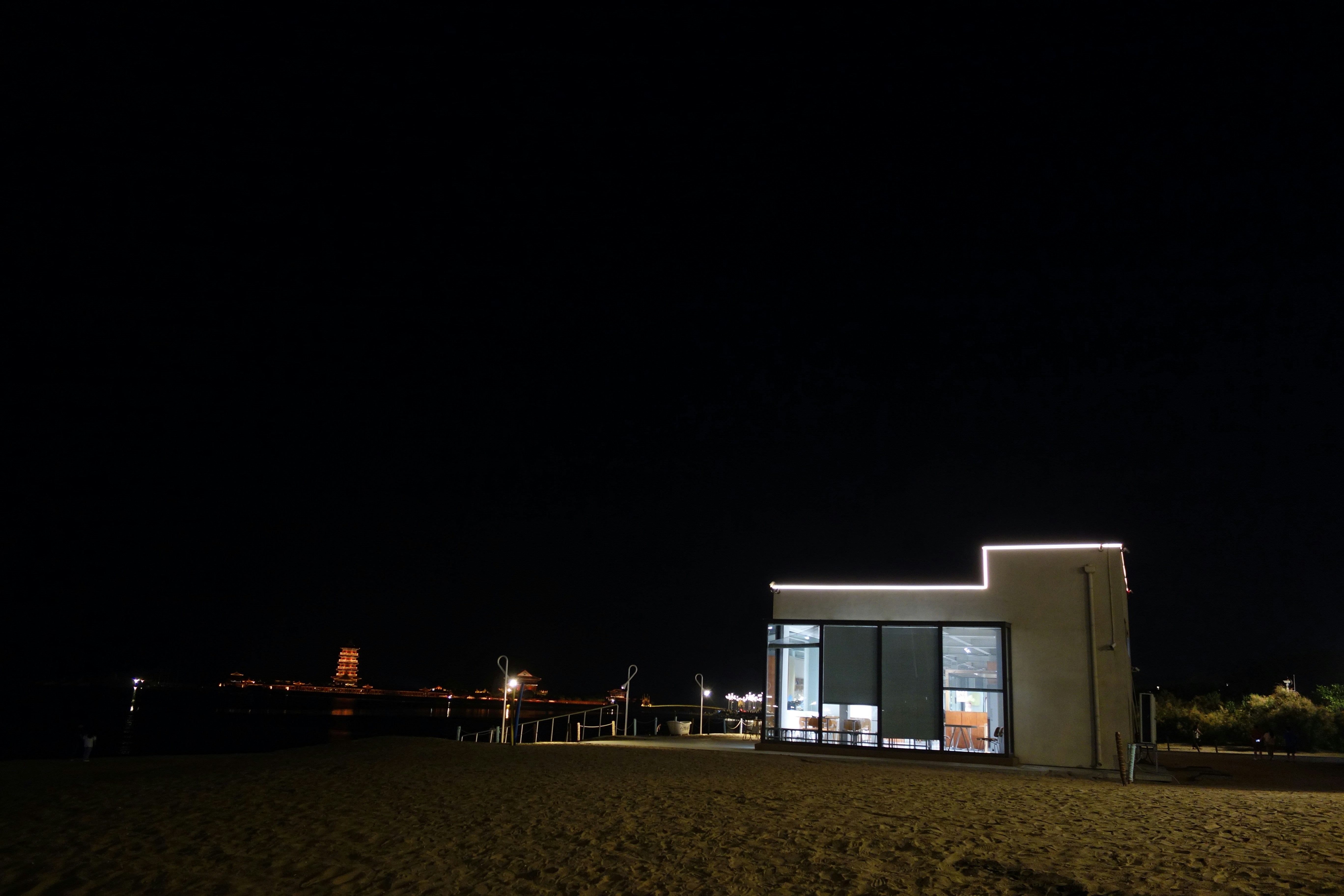 Lone Beachfront Pavilion at Night with Neon Rim