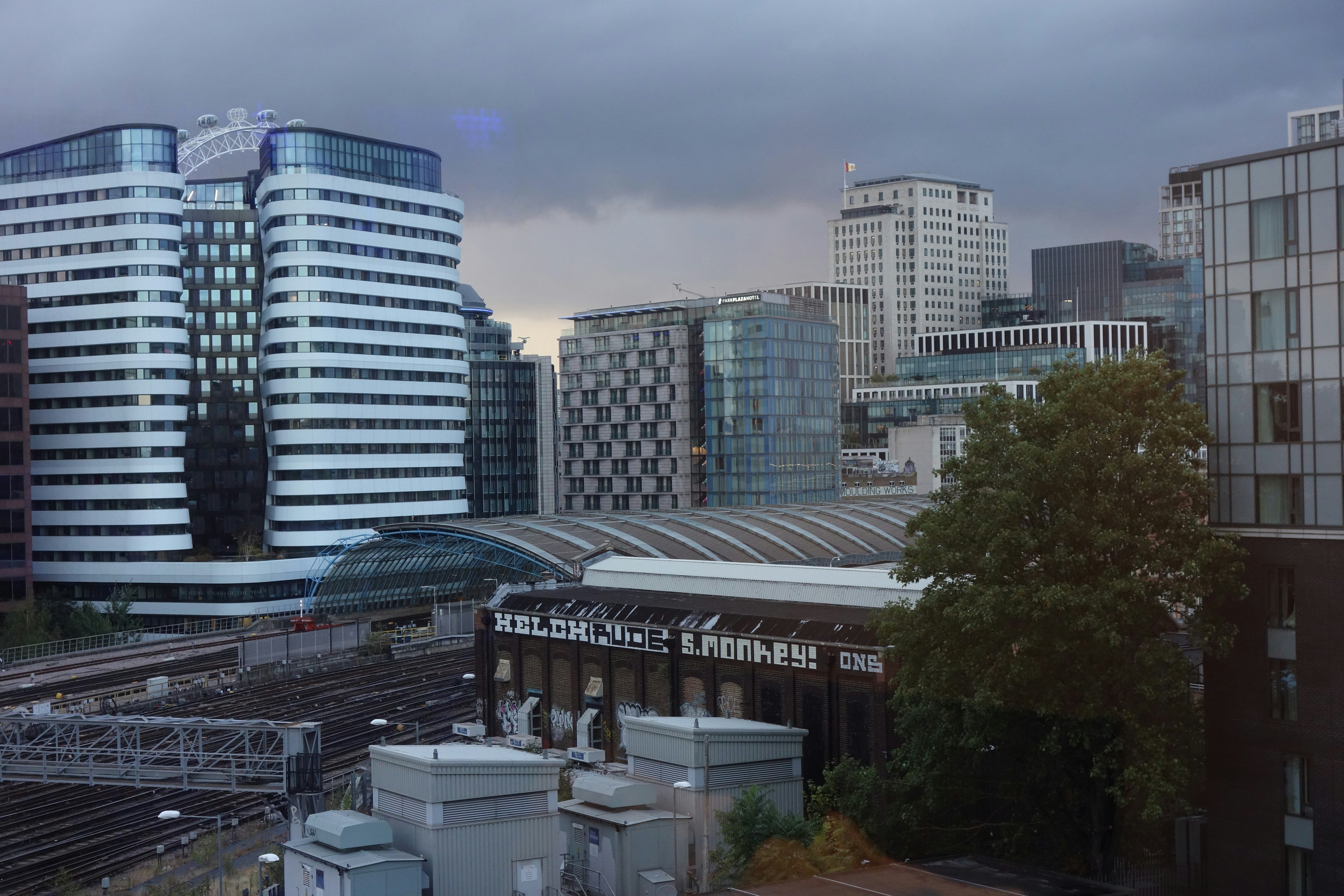Cityscape Rhythm: Modern Towers Meet a Glass Roofline