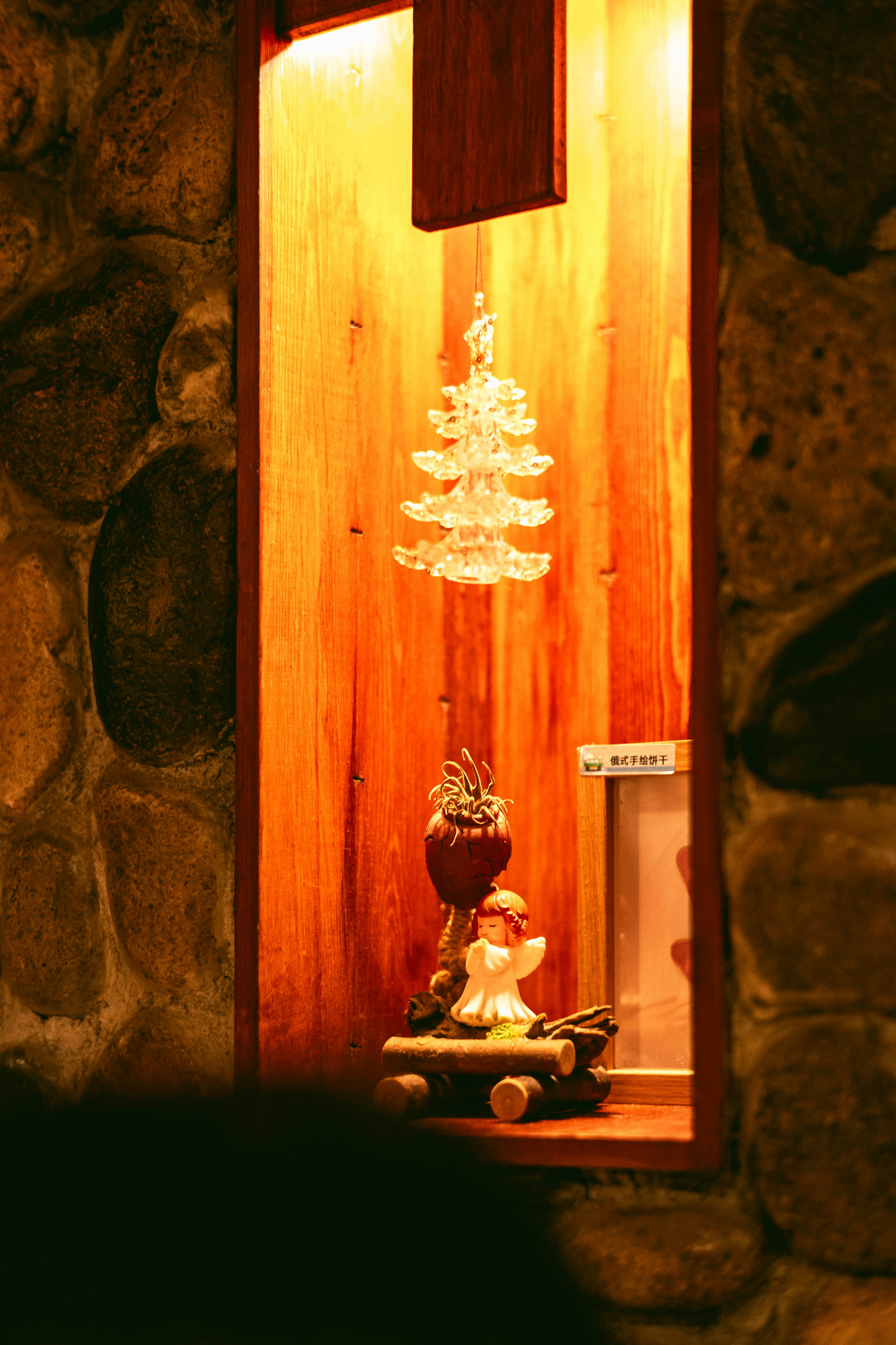 Warm Shrine Window: A Tiny Figurine Under Amber Glass