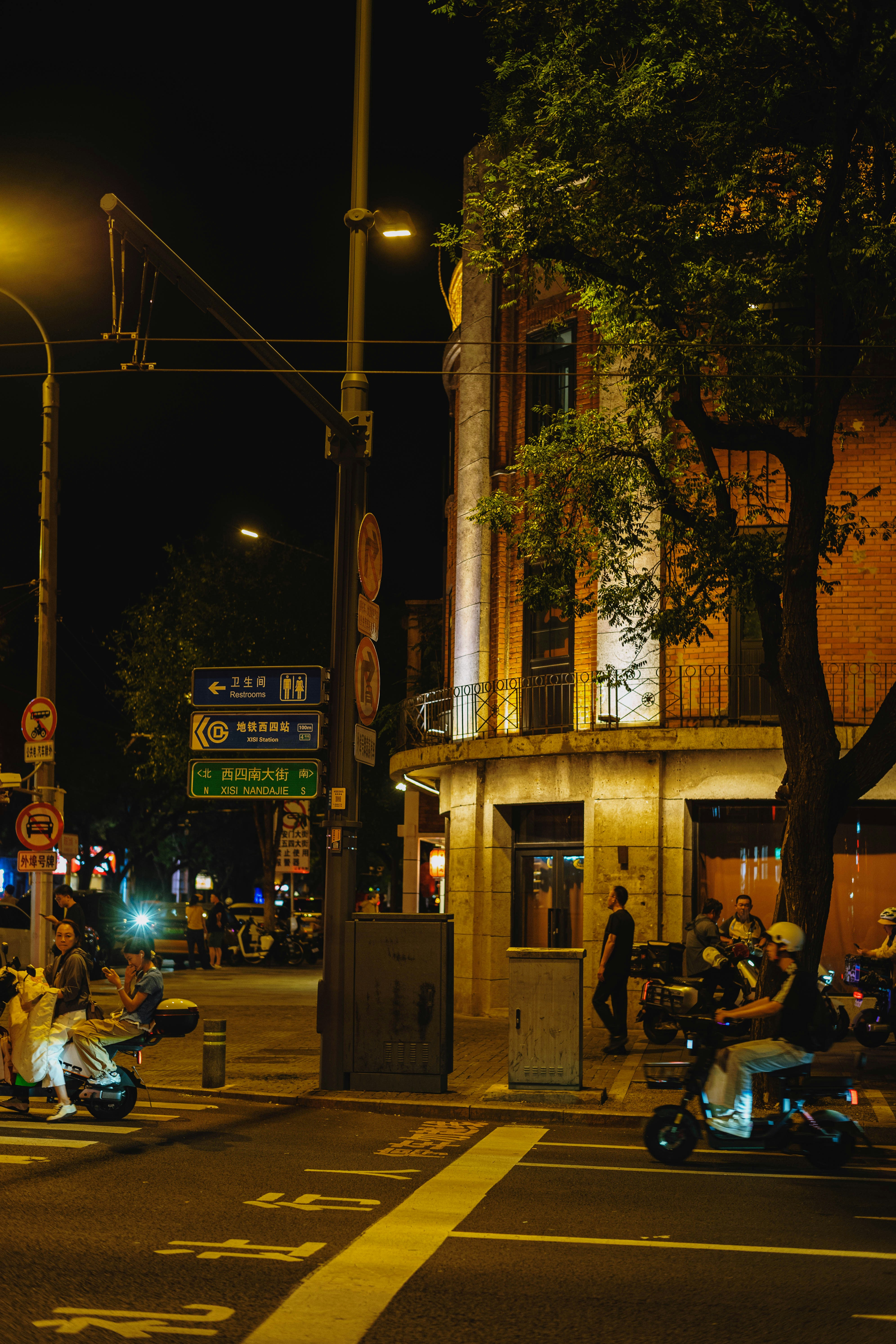 Night Crossroads: Neon, Scooters, and Silent Signposts