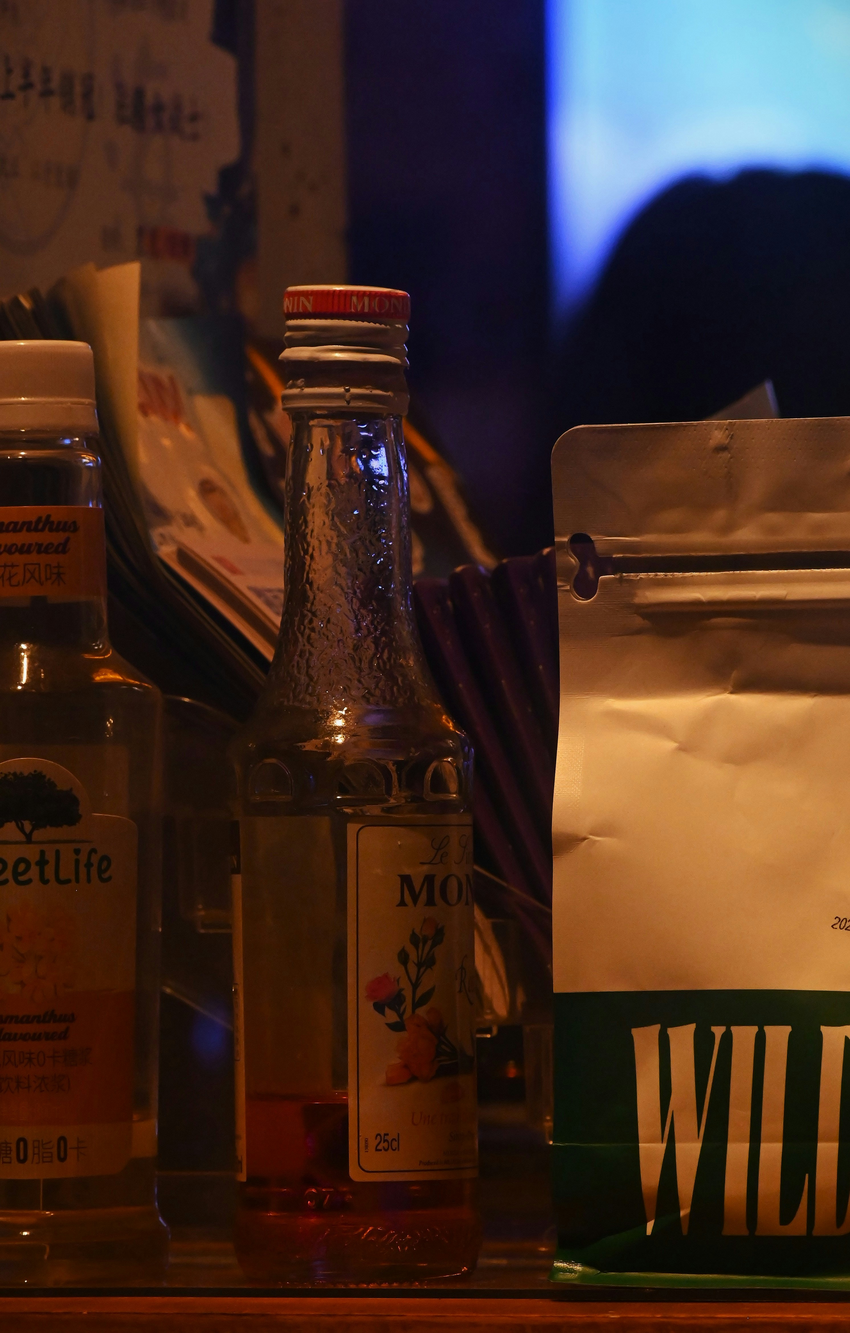 Amber Bottles and Snack Pack Rest on a Dim Counter