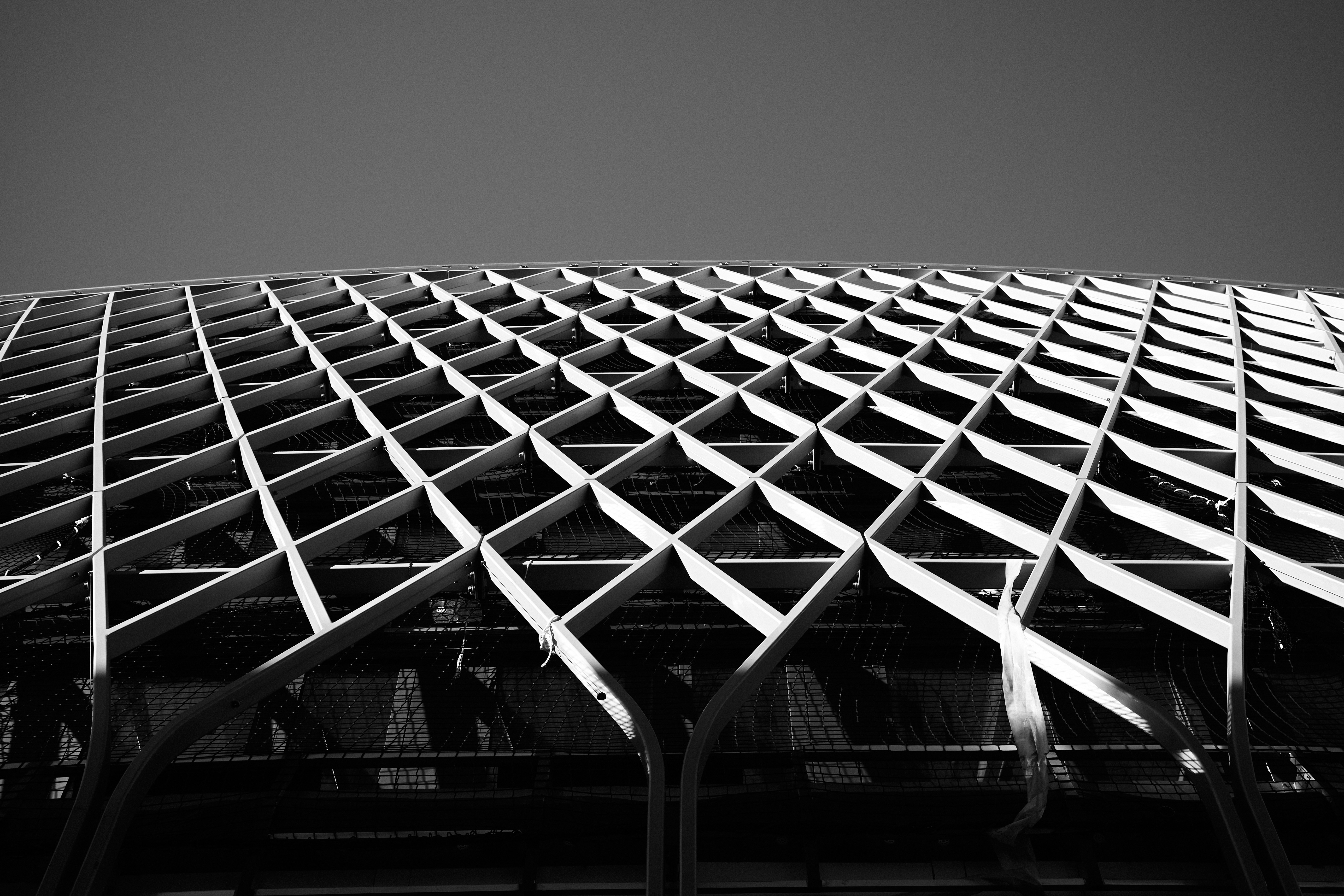 Crisscrossed Facade: A Looming Mesh of Steel and Shadow