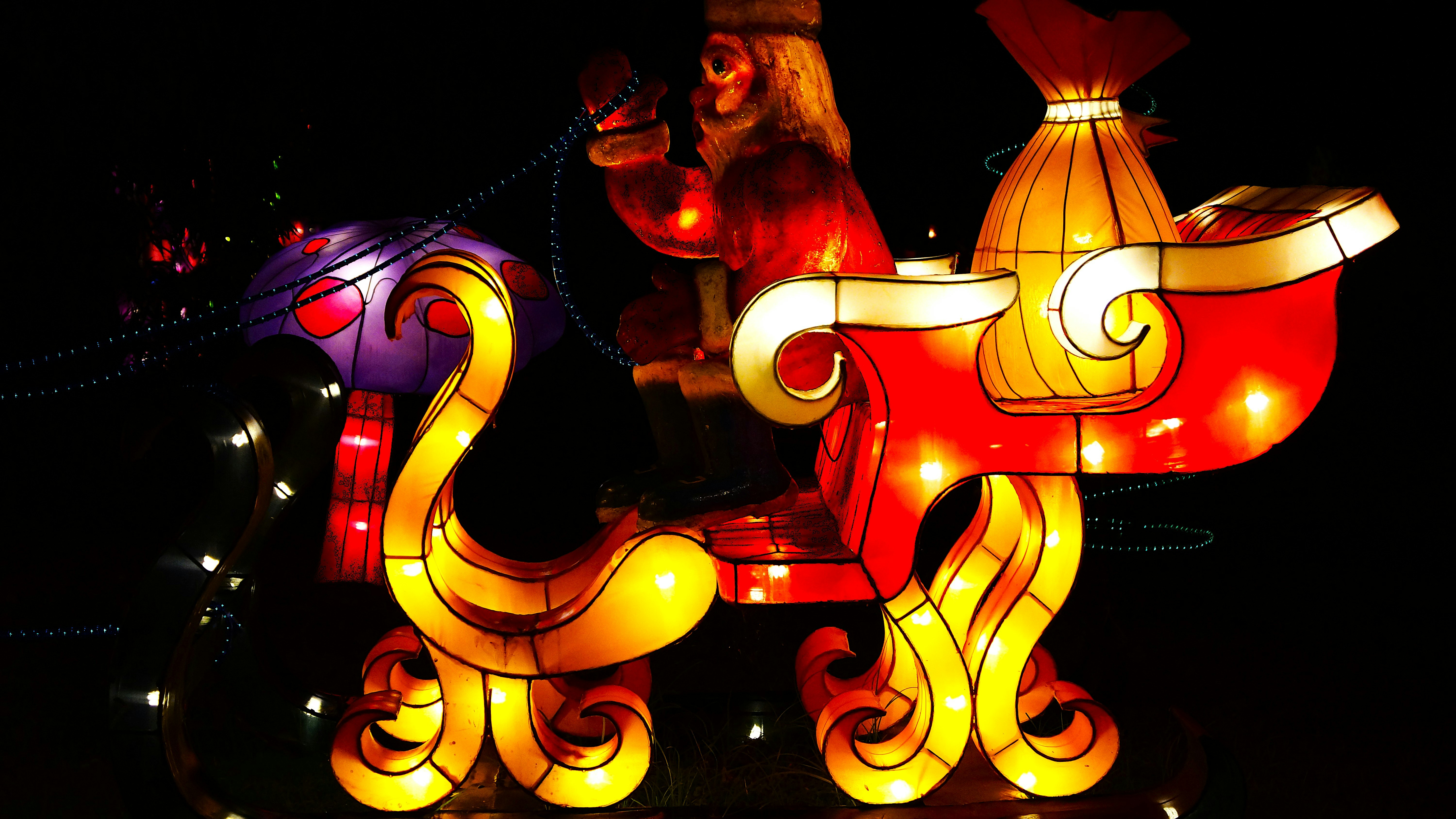 Glowing Carousel Spectacle: A Nighttime Neon Horse Carriage