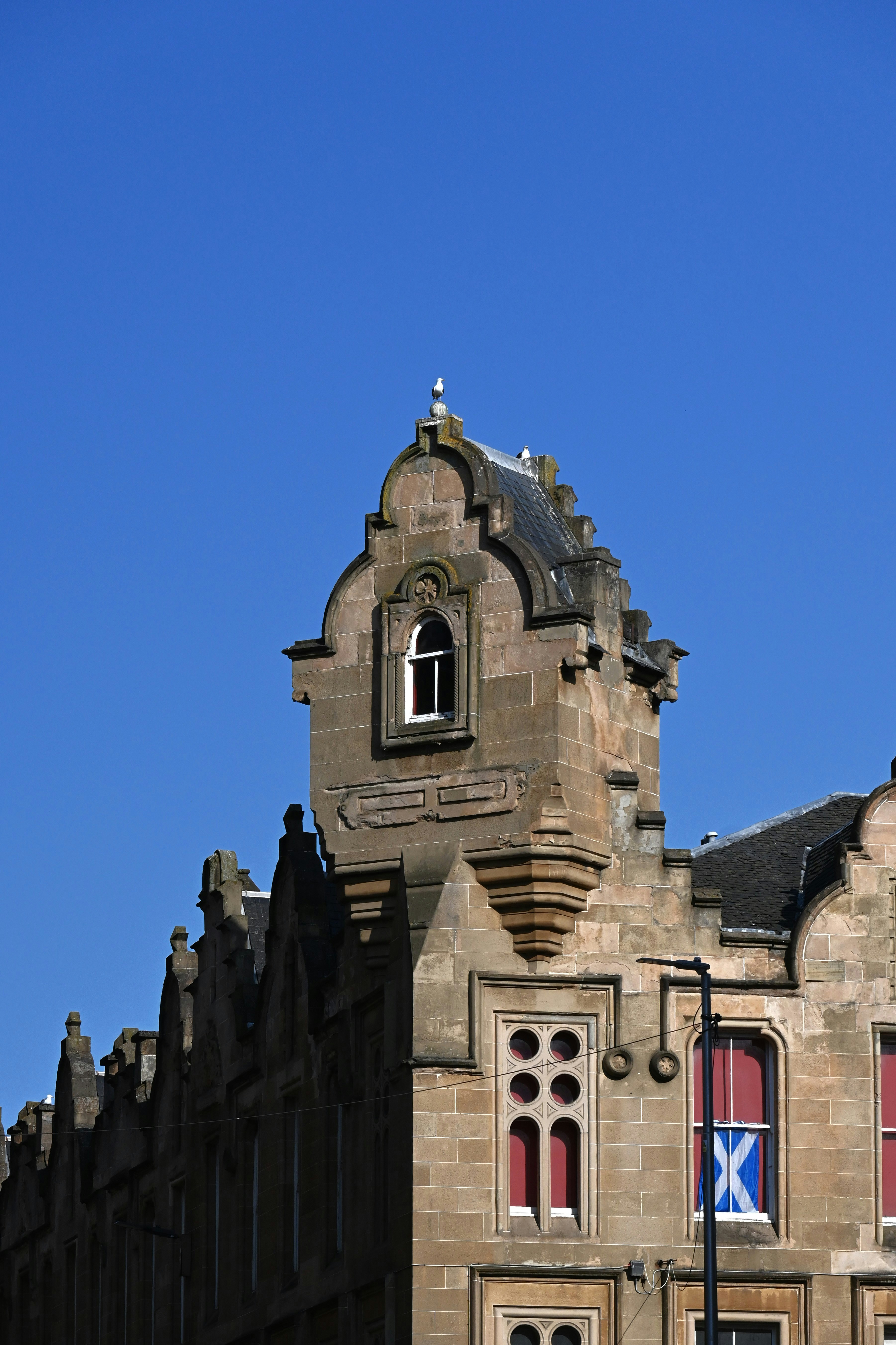 Stone-gabled Clocktower Rising Against a Clear Blue Sky