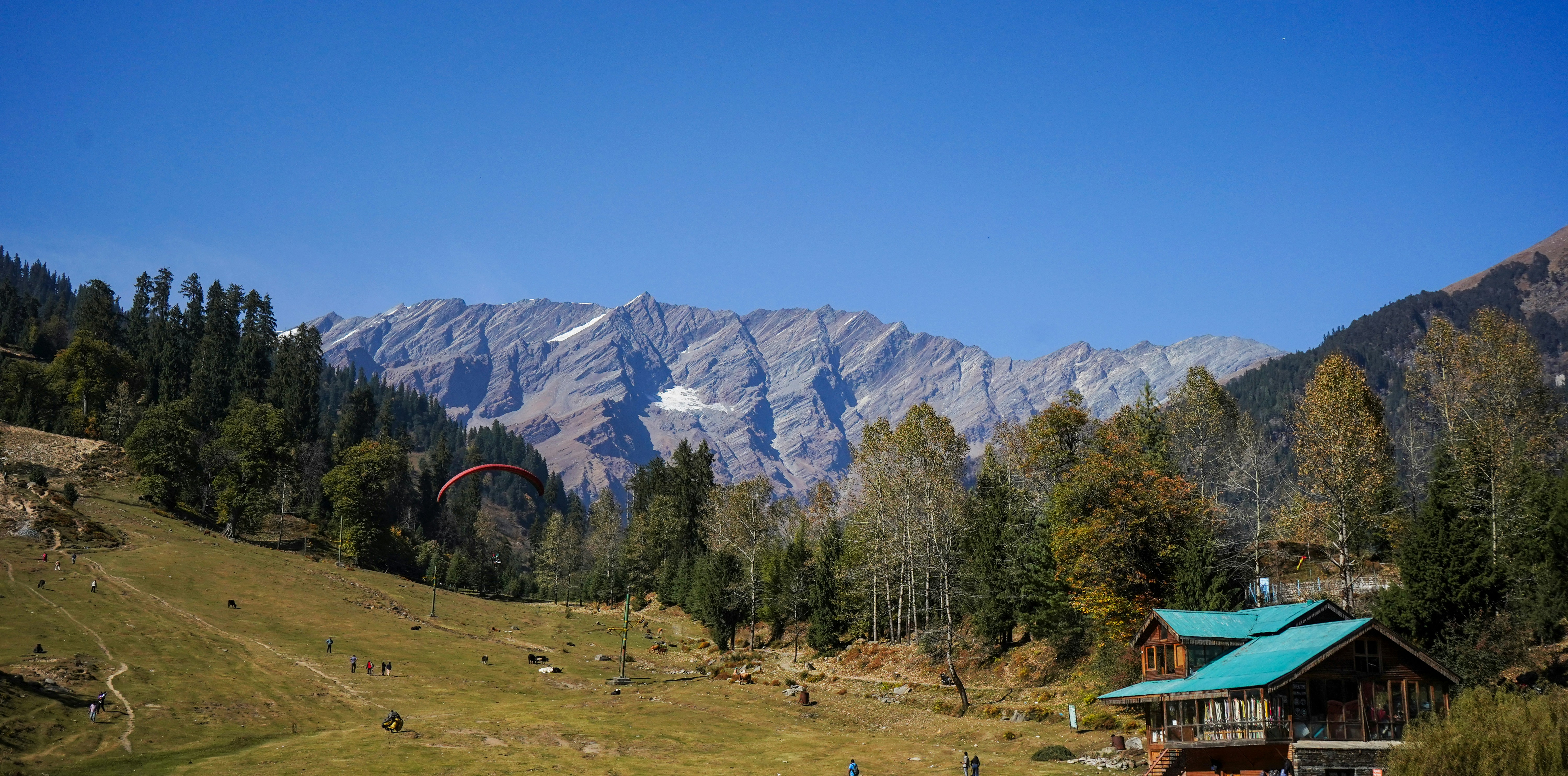 Alpine Valley Farmhouse Under a Clear Blue Sky