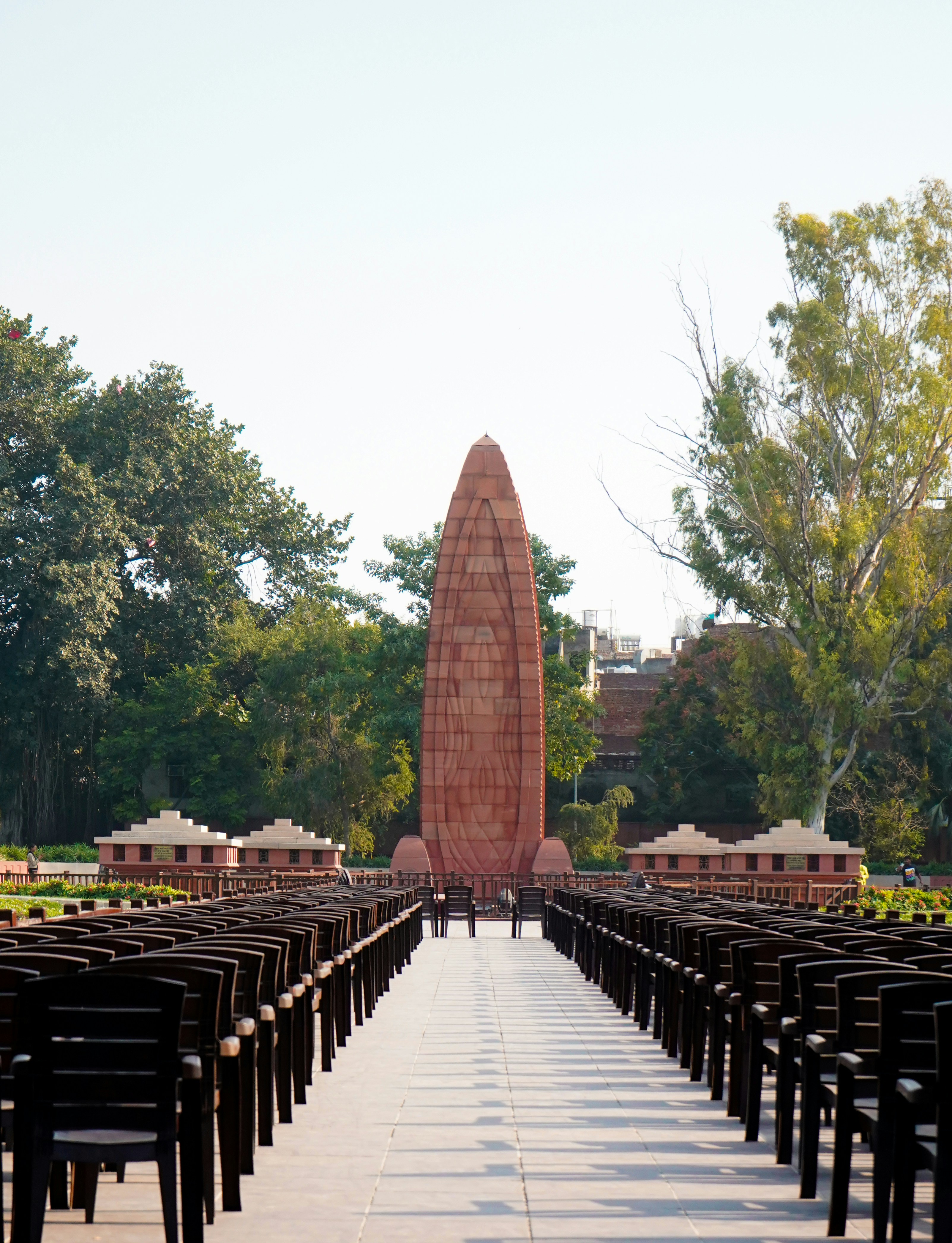 Monumental Obelisk Framed by Rows of Benches in a Sunlit Park