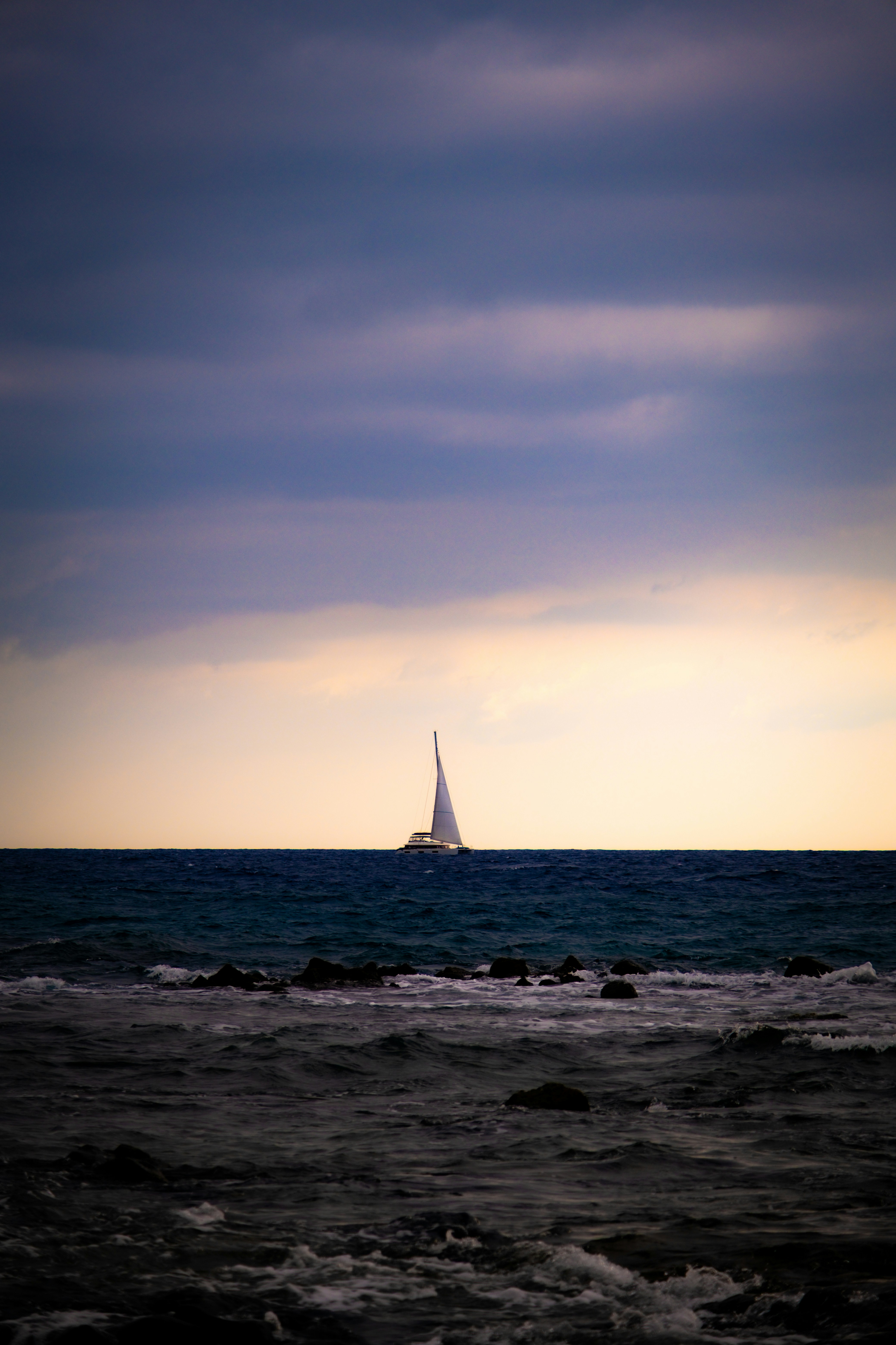 Sailboat on a Quiet Horizon at Dusk