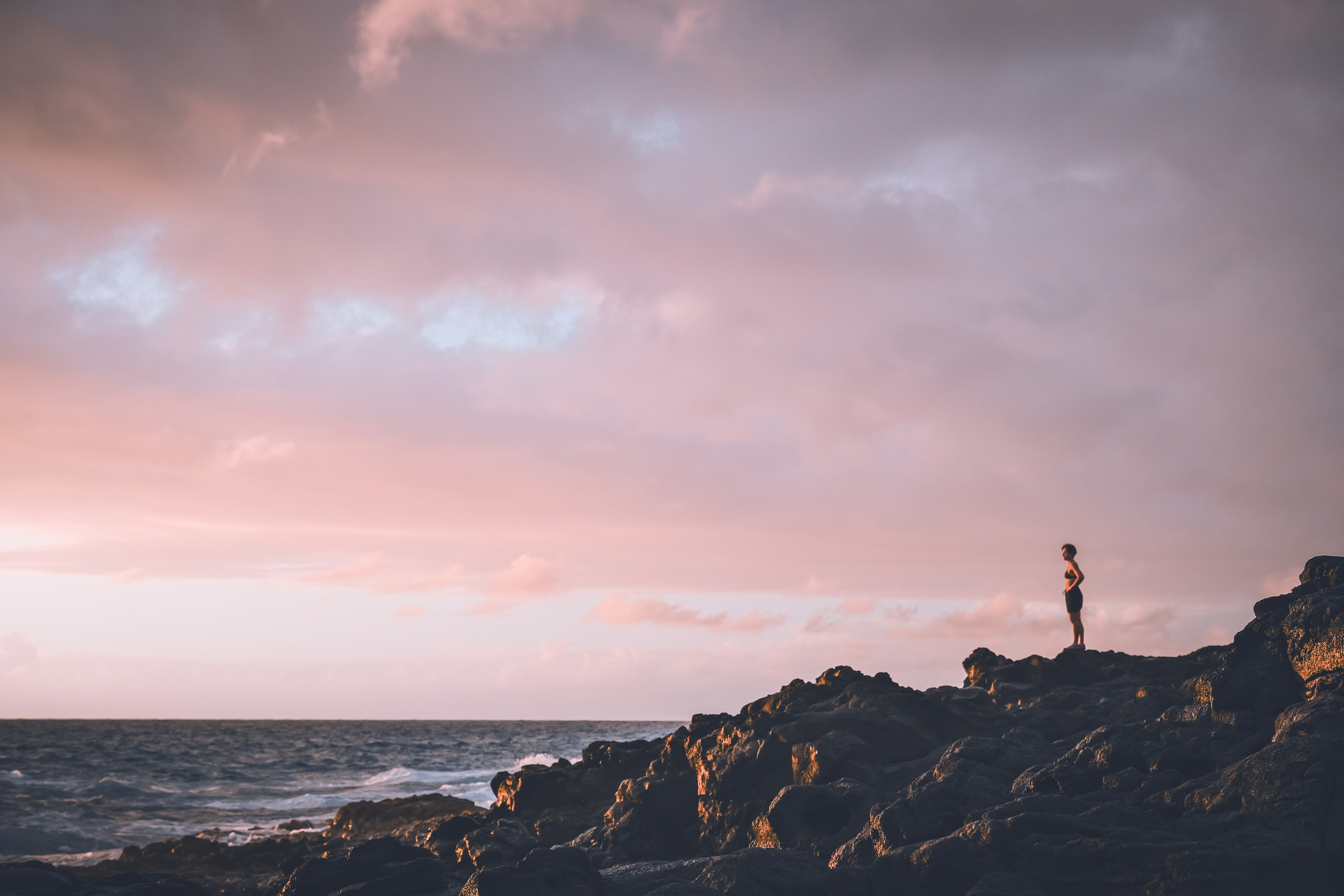 Quiet Climber on Jagged Shore at Dusk