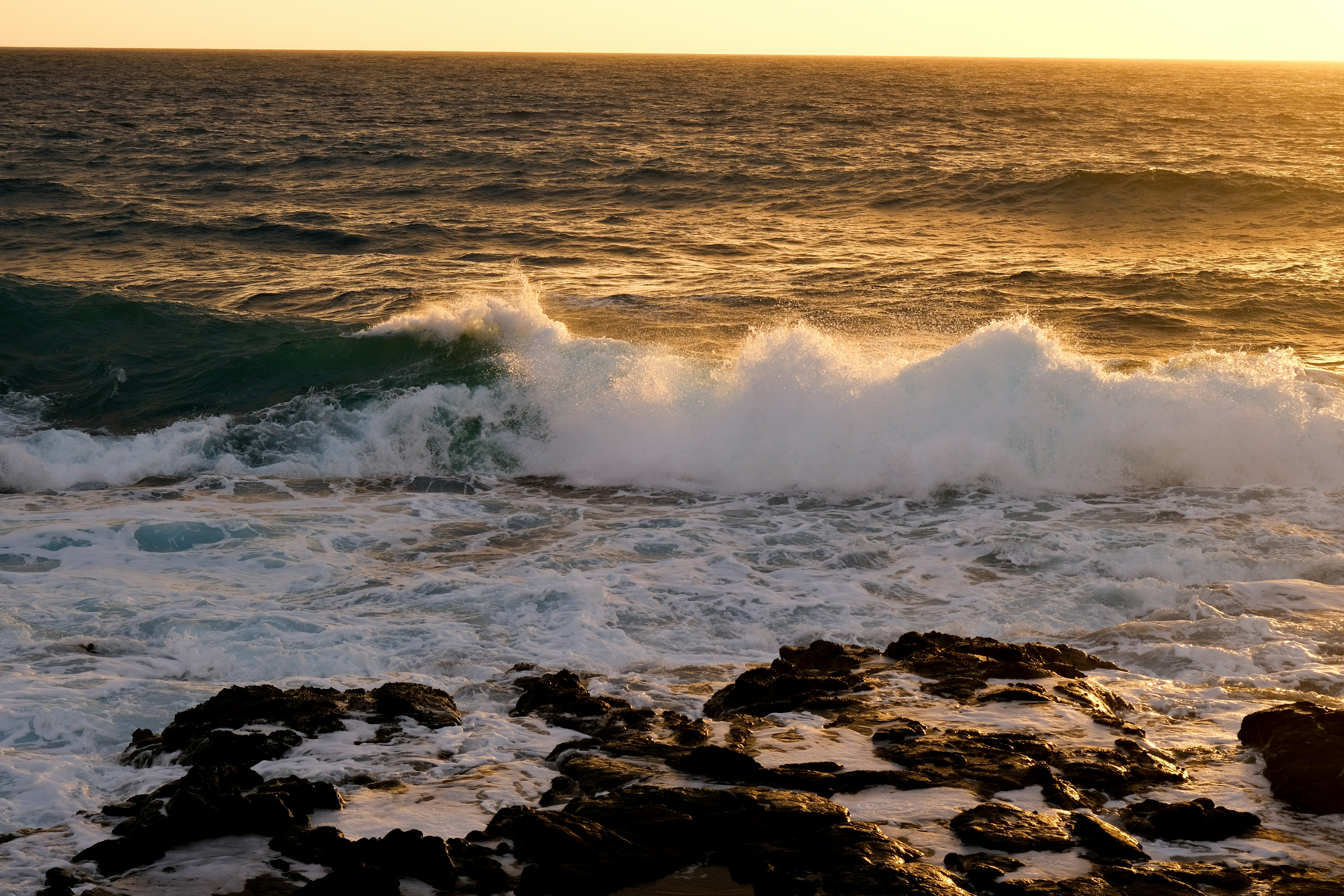 Golden Crest over Tides: Sunset Light on Windward Rocks