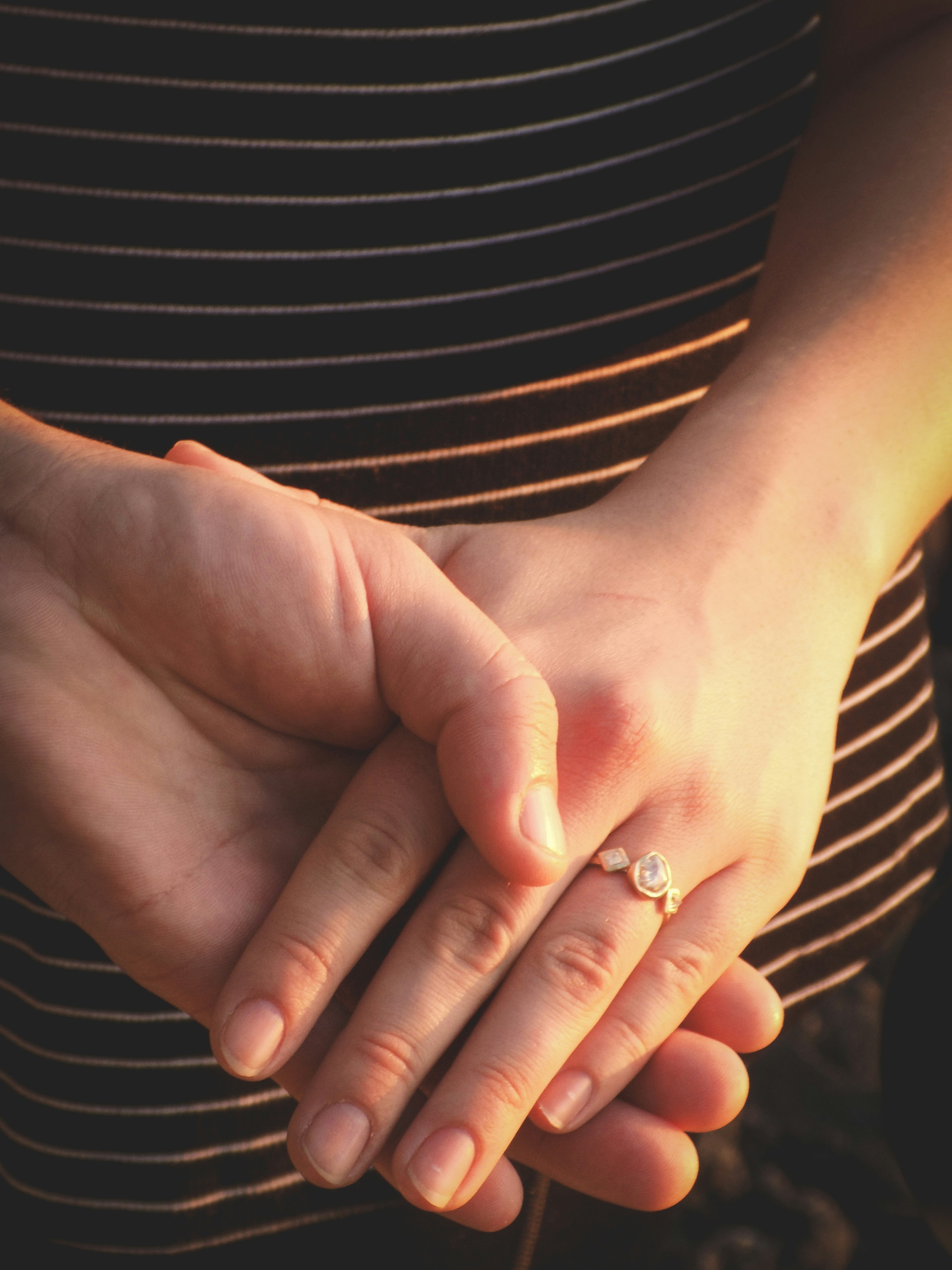 Intertwined Moments: A Gentle Hold and a Promise Ring