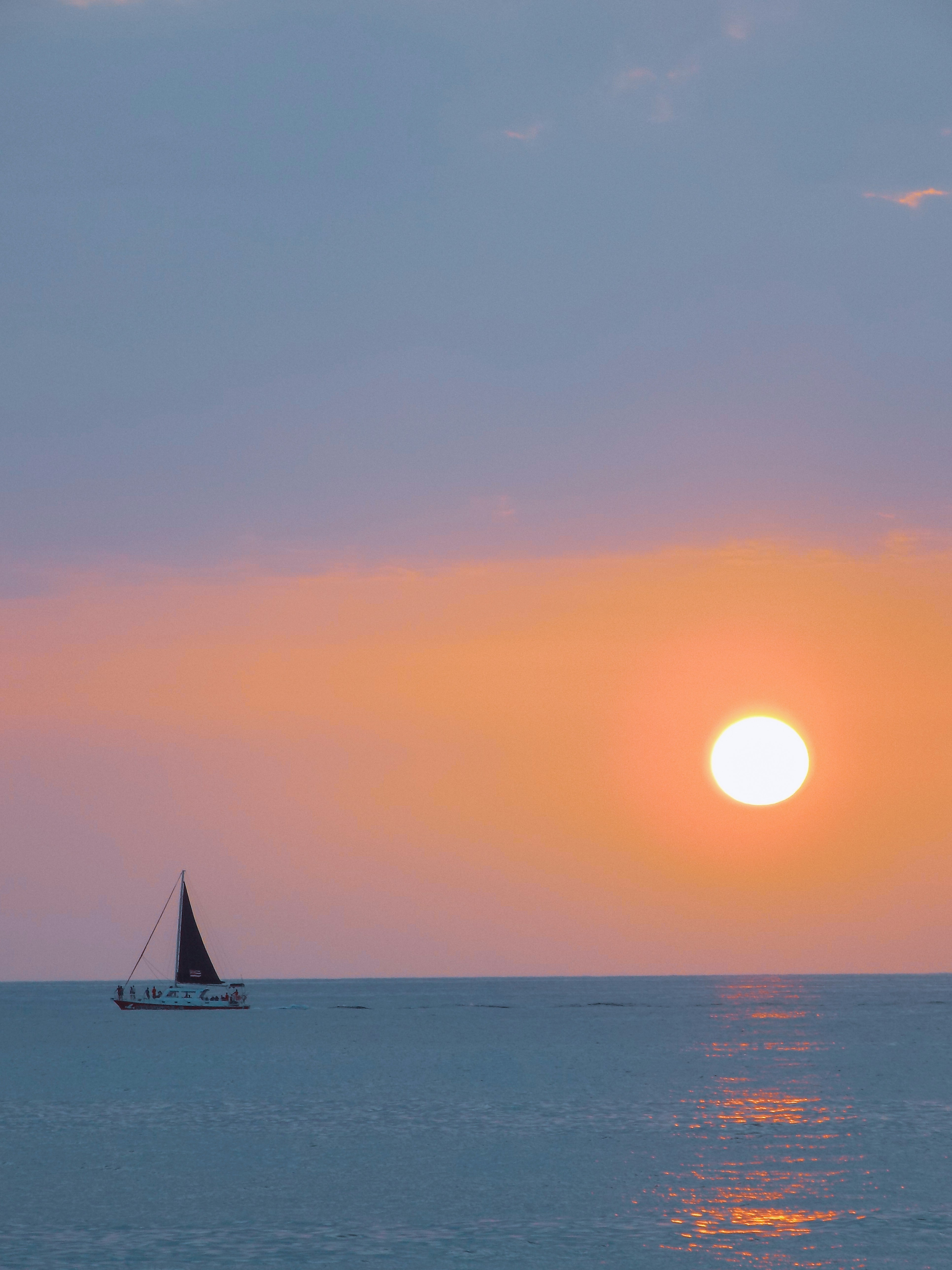 Sunset Sail: A Quiet Horizon with a lone sailboat