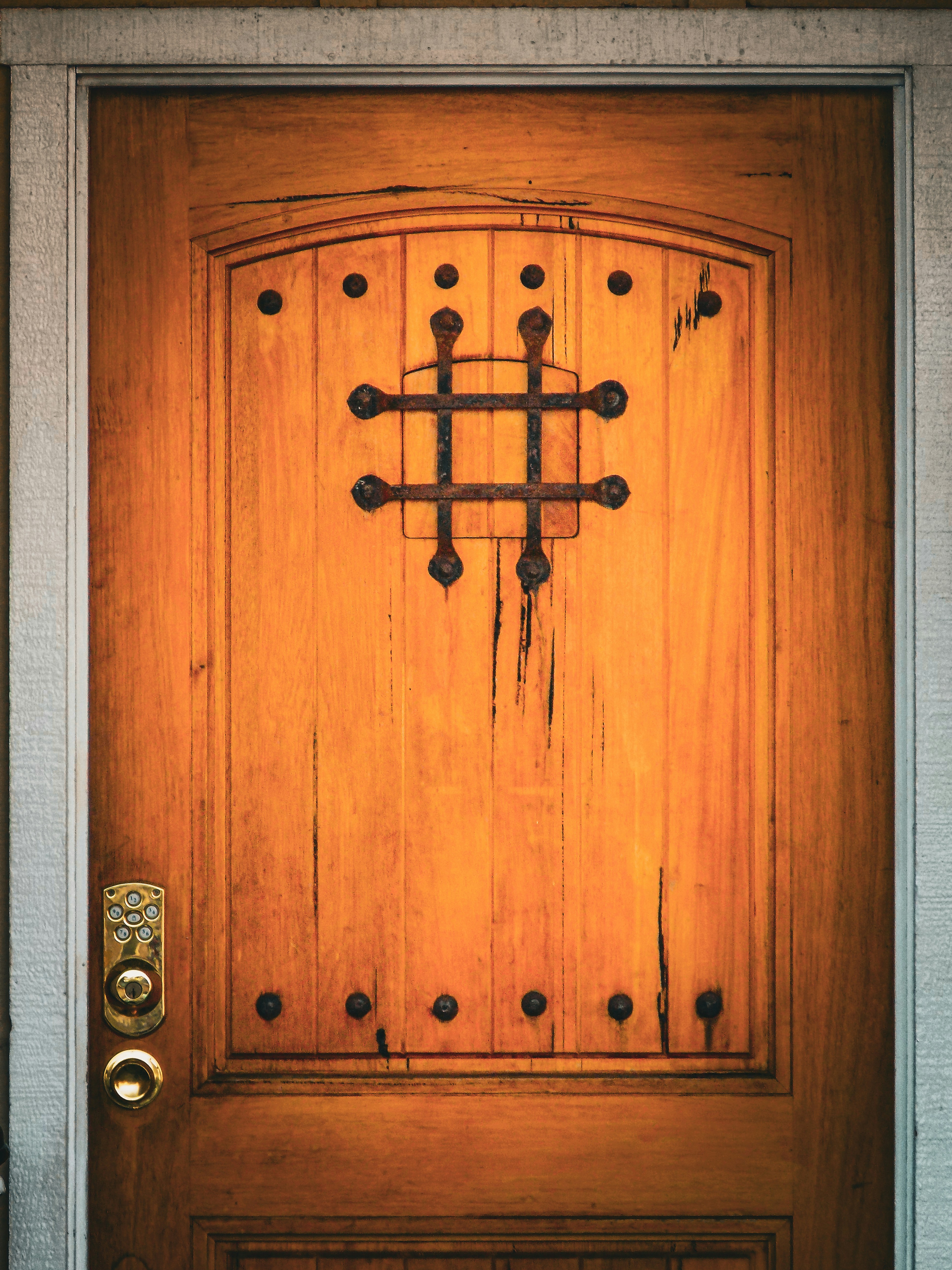 Ironbound Symmetry: Handcrafted Door with Rustic Accents