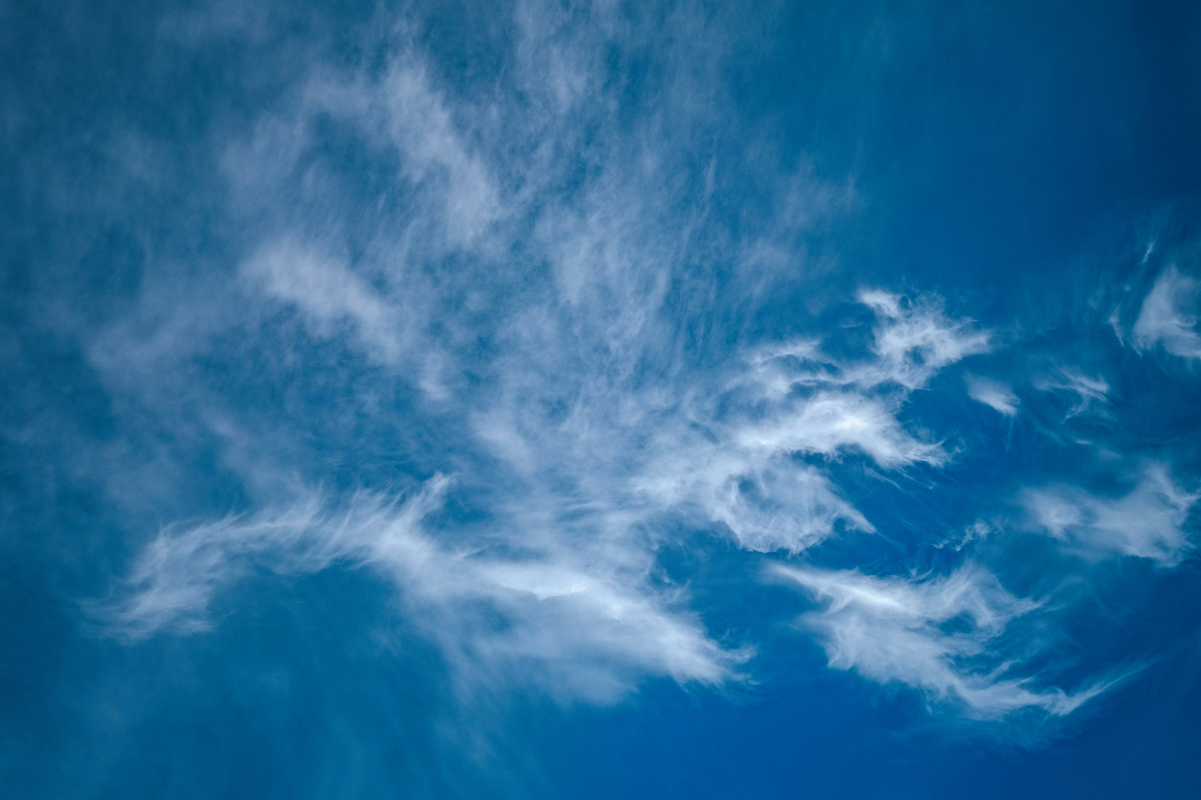 Vast Blue Span with wispy clouds drifting across