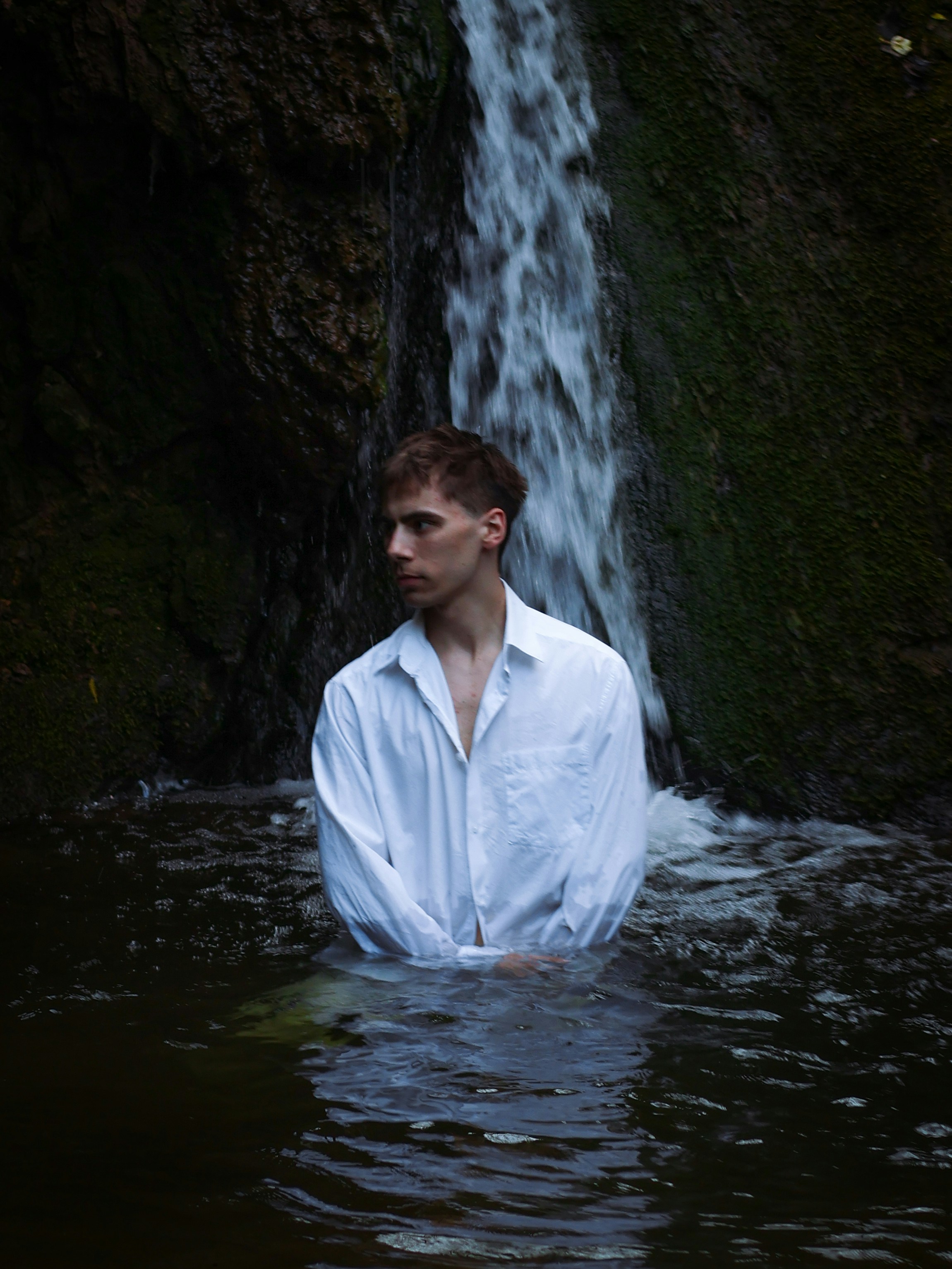 White Shirt in Cascade: A Quiet Portrait by the Waterfall