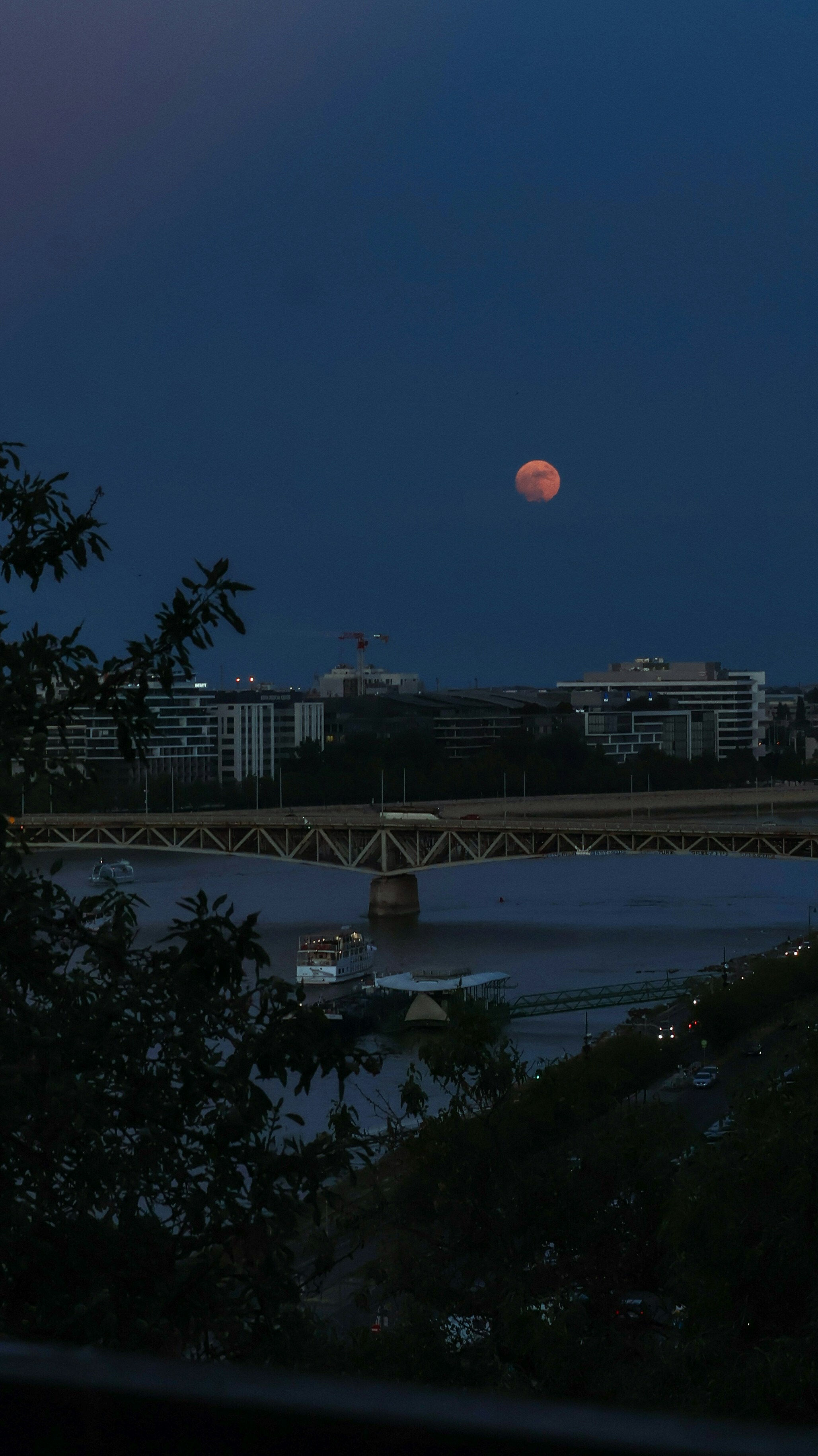 Moonrise over the City: A Silent Riverside at Dusk
