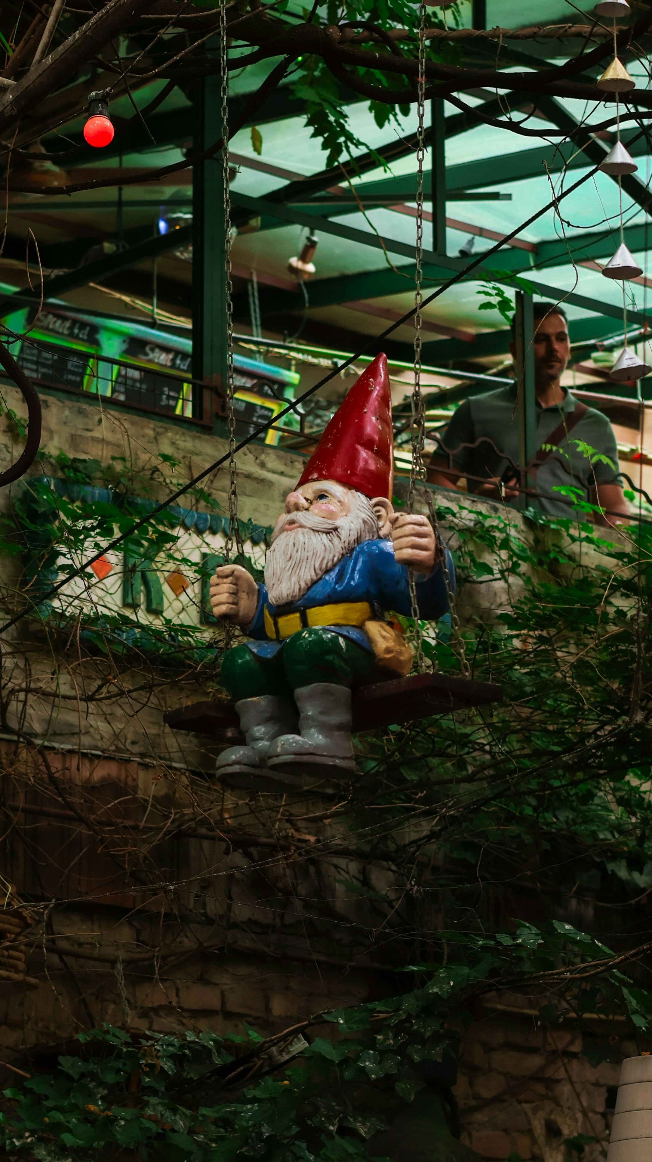 Garden Gnome on a Swing: A Quiet Visitor in the Greenhouse