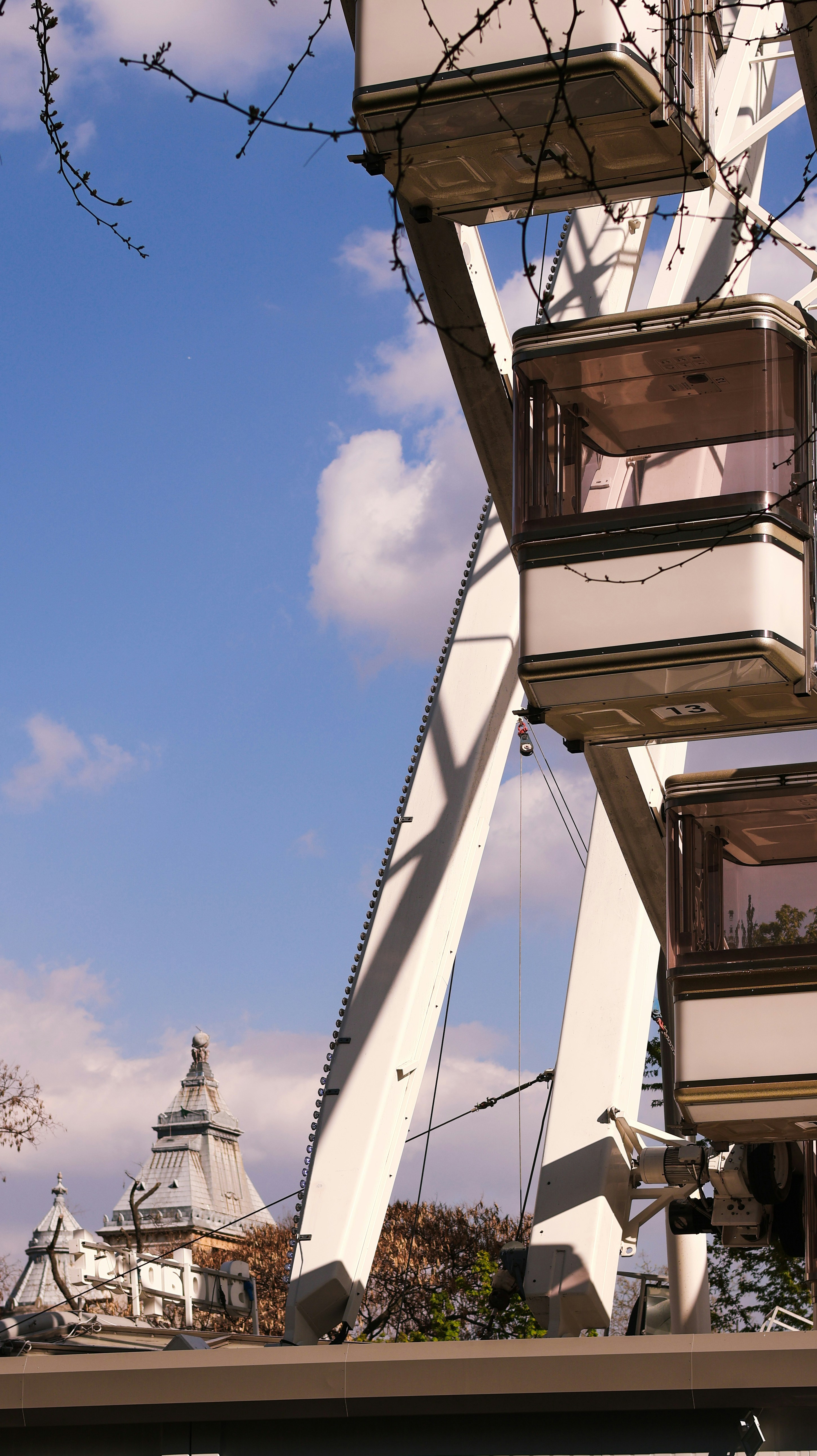 Gondola Frames Against Sky: A City Wheel and Cable Car Towers