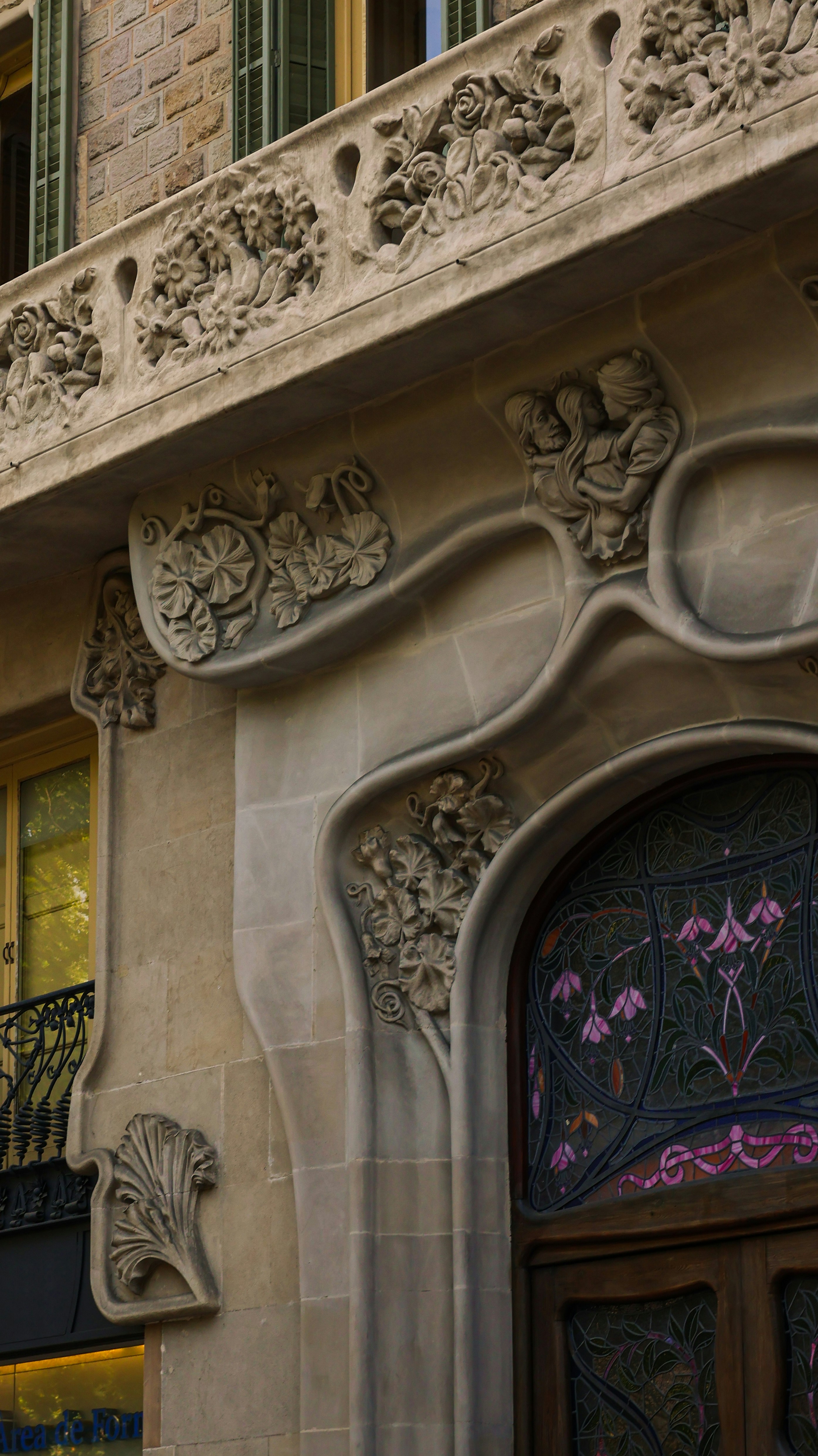 Ornate Facade Mystery: Gilded Stonework Framed by Stained Glass