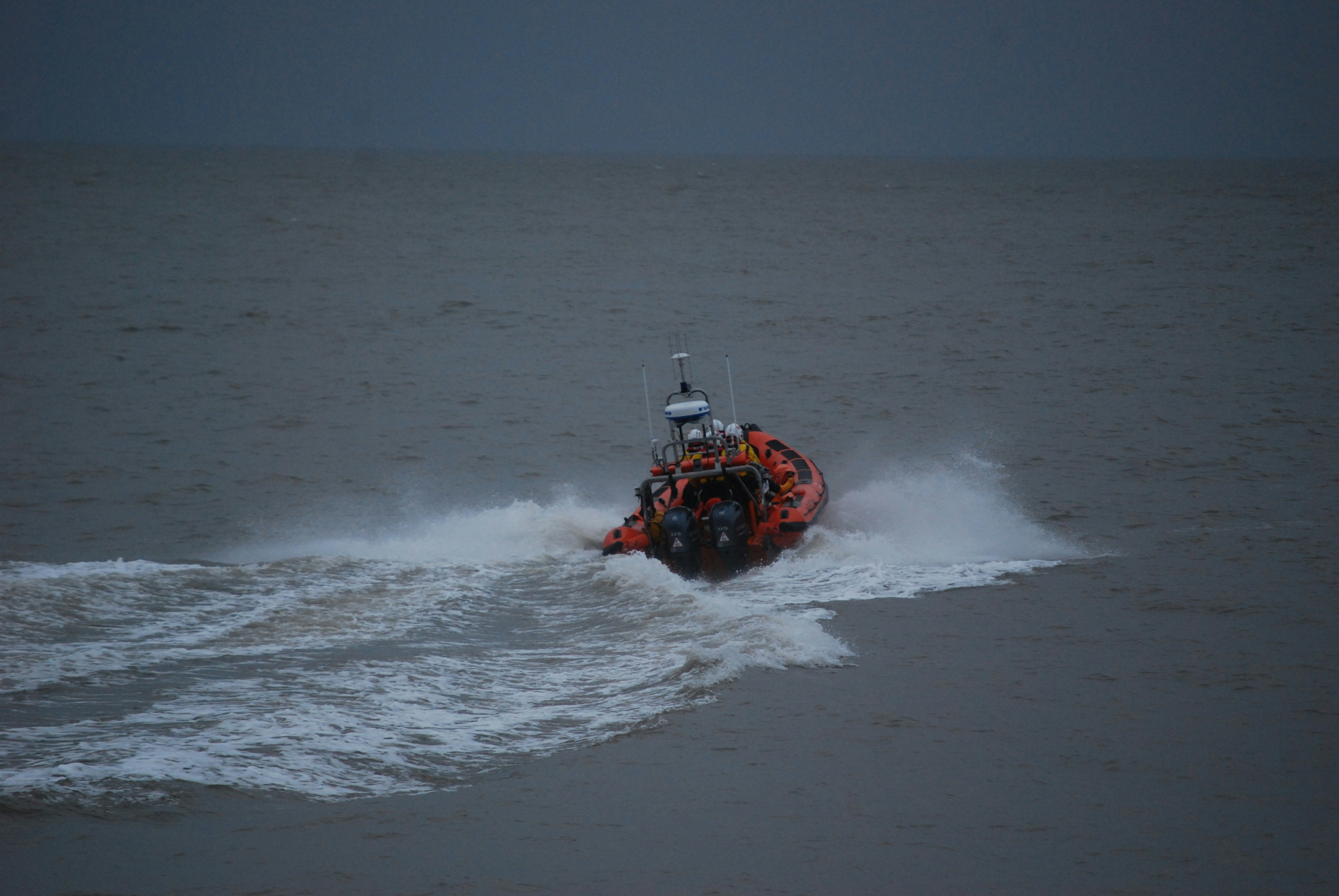 Rough Seas, Red Rigid: RIB Cutting Through a Wake