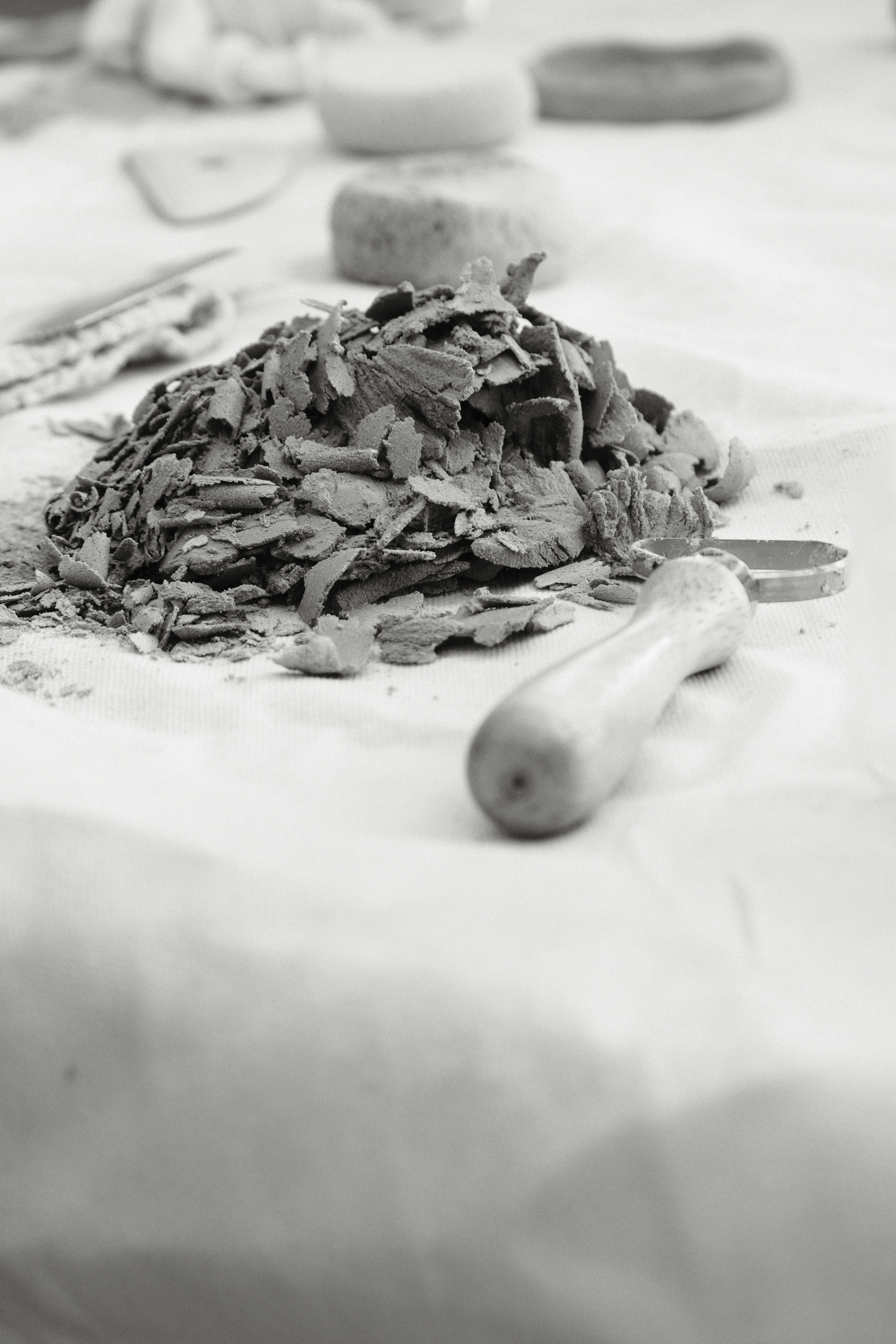Pile of chocolate shavings on a table with a knife in the foreground
