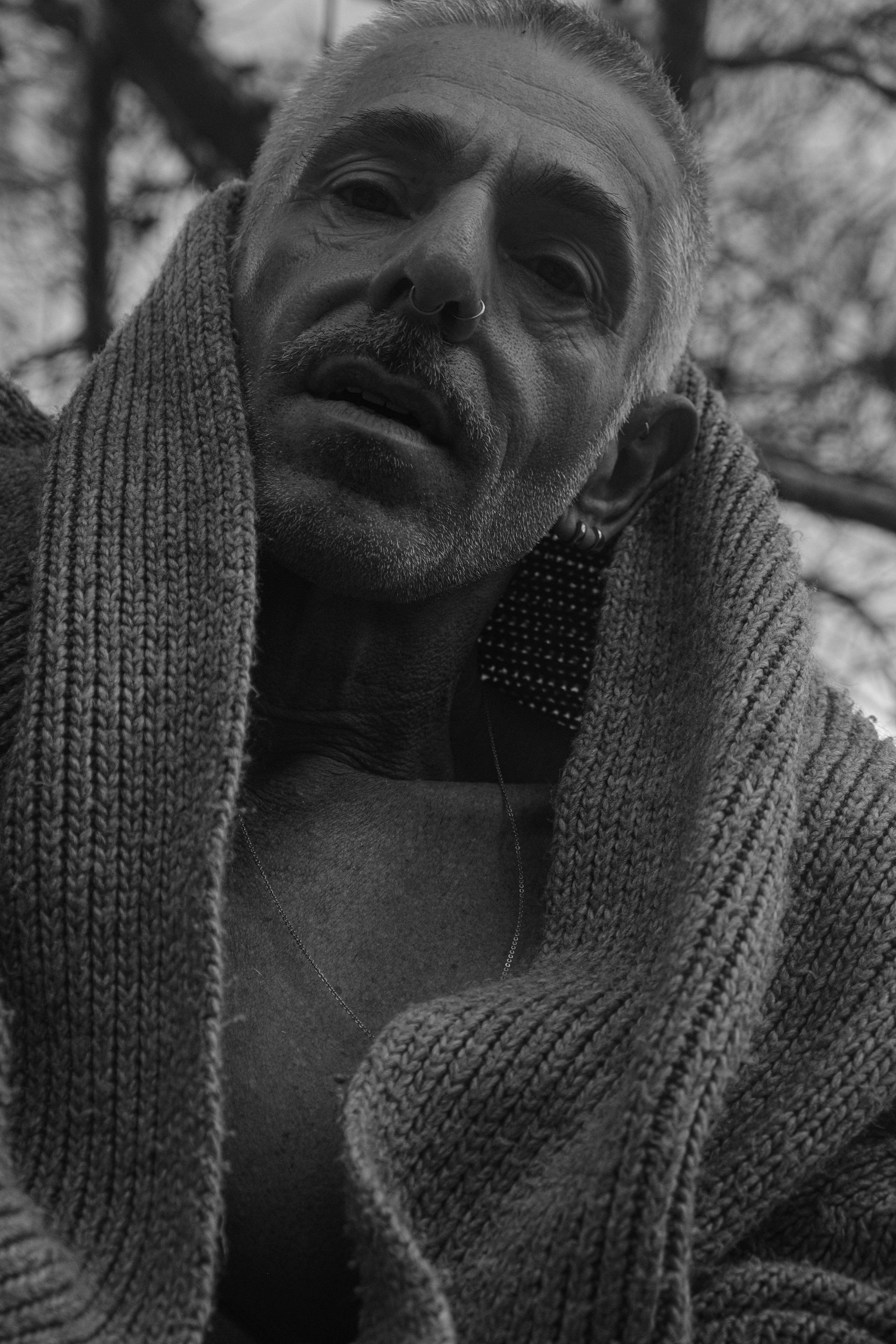 Portrait in Monochrome: A Weathered Gaze Wrapped in Knit Shadows