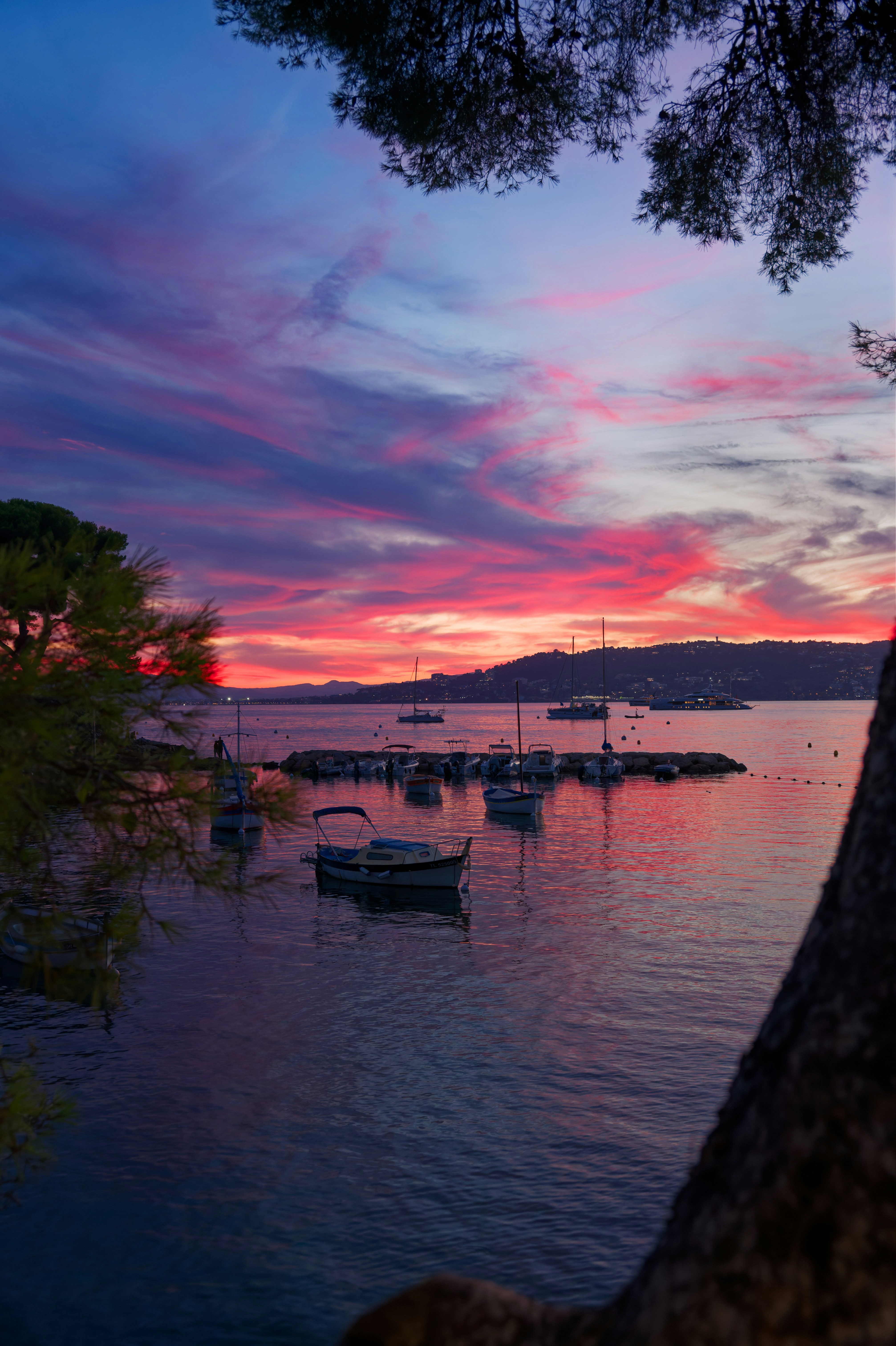 Sunset Harbor: Boats Rest at Dusk Amid Quiet Waves
