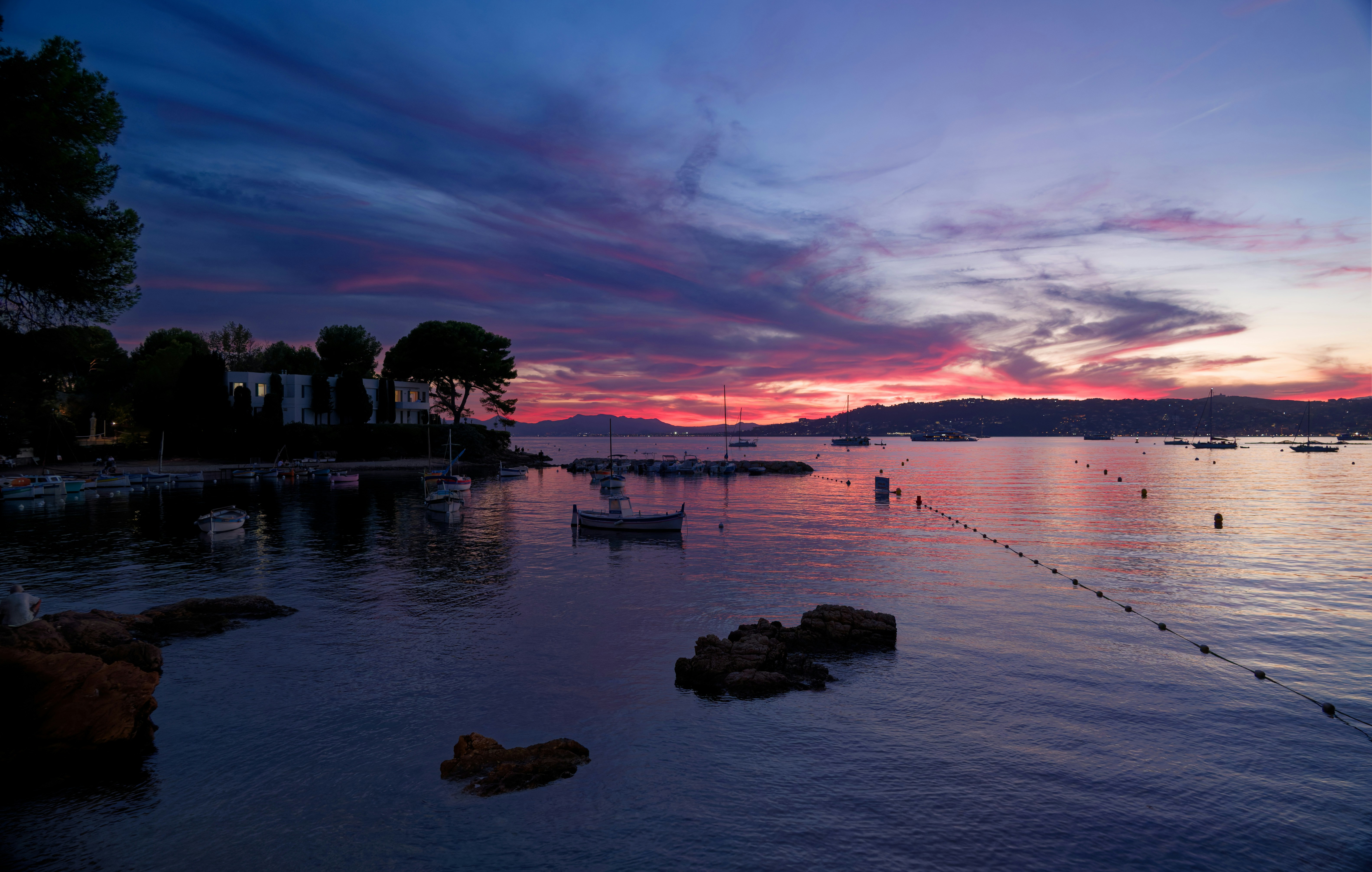 Twilight Harbor: Boats, Rocks, and a Quiet Sunset