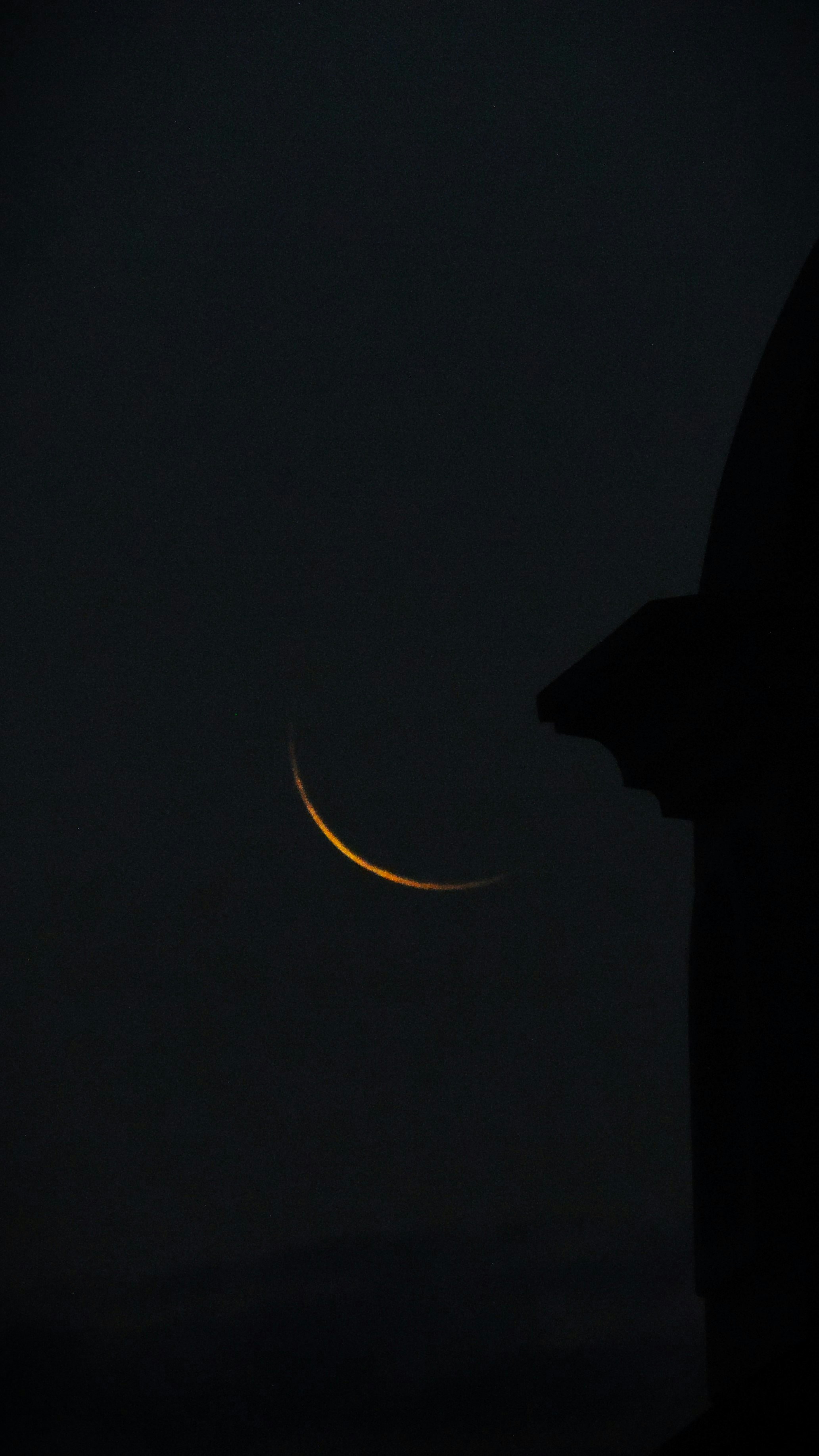 Crescent Moon over a Silent Building Silhouette