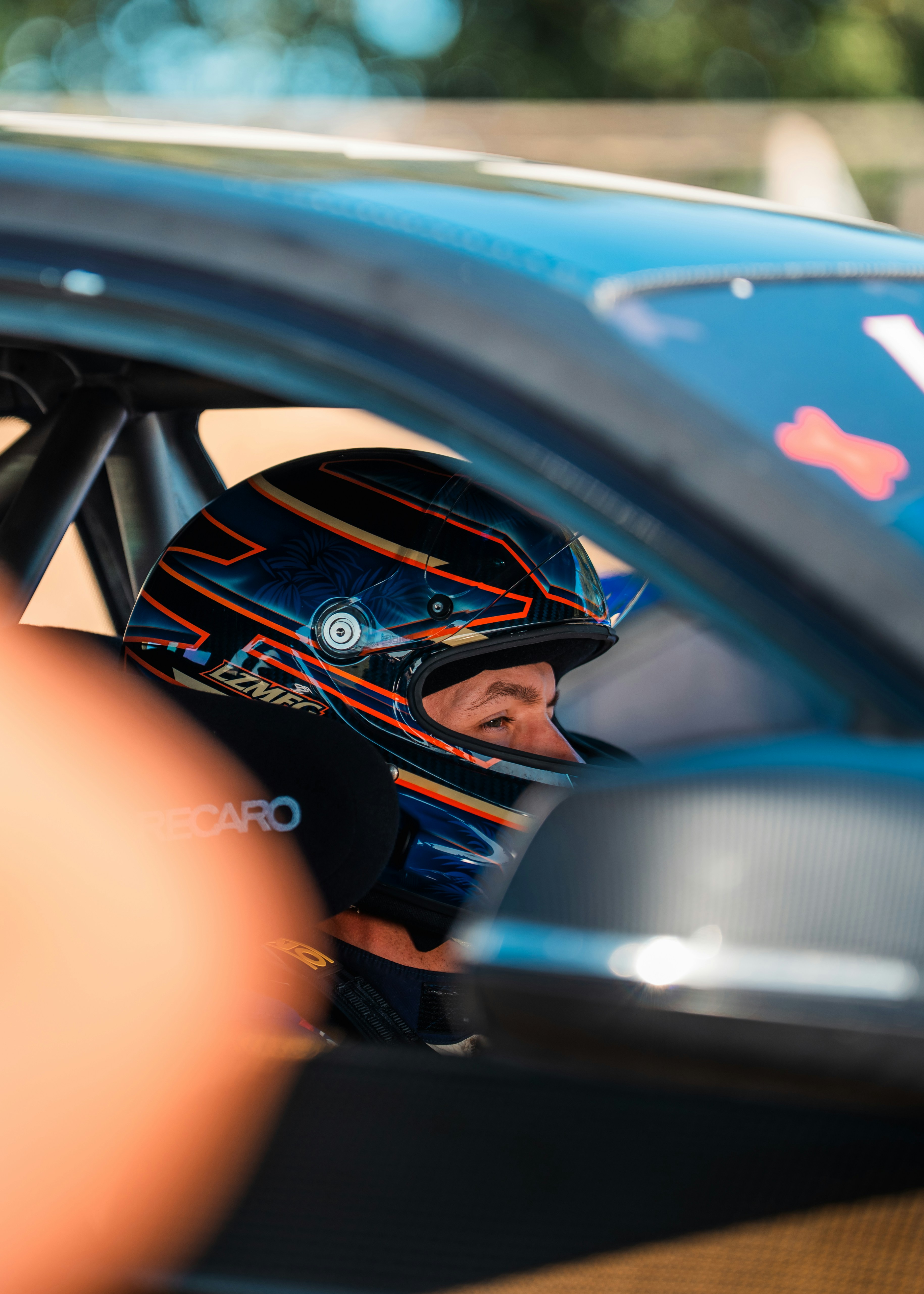 Helmeted Focus: Racer’s Gaze through a Car Window
