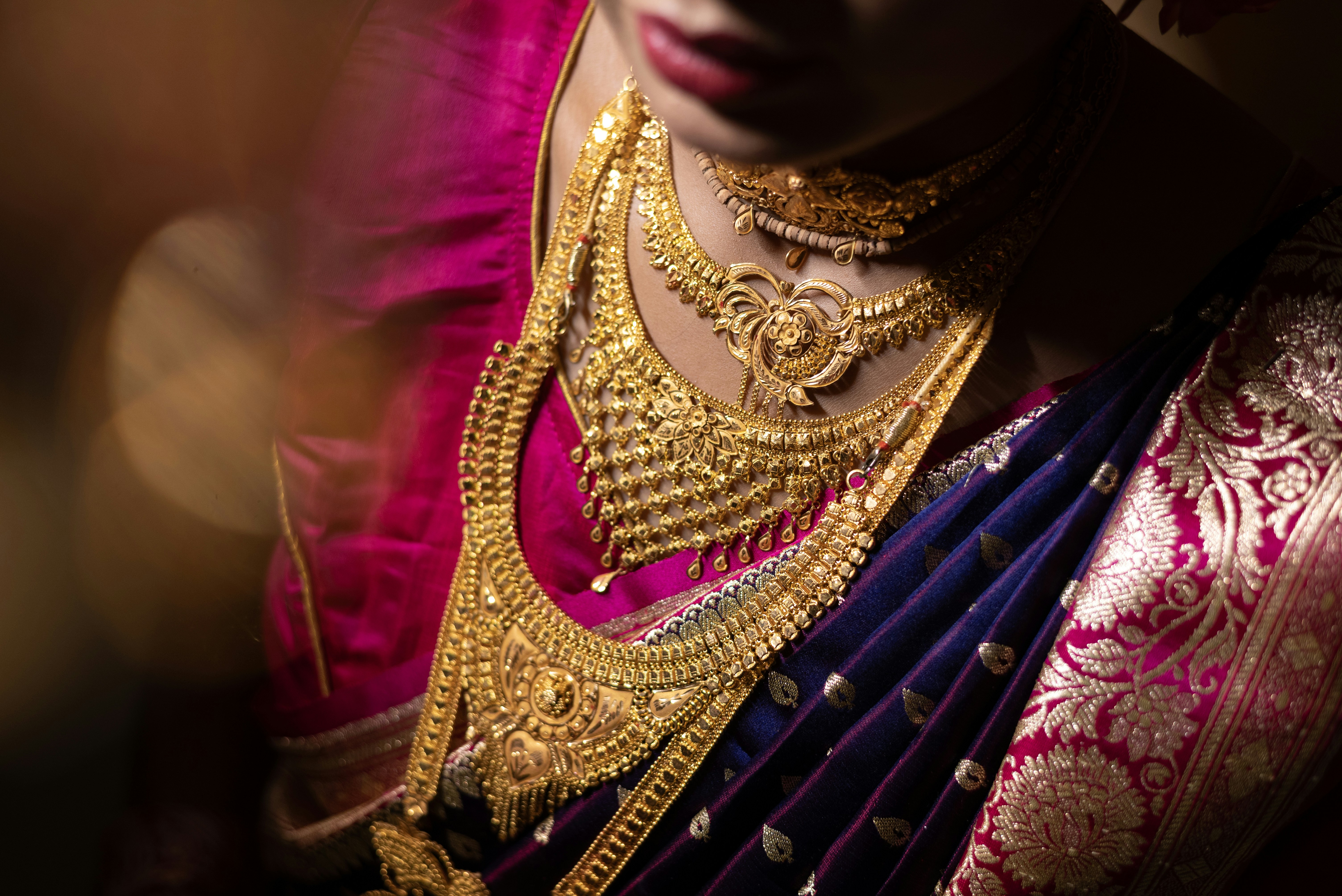 Golden Adornments: A Portrait of Regal Jewelry Against Rich Silk