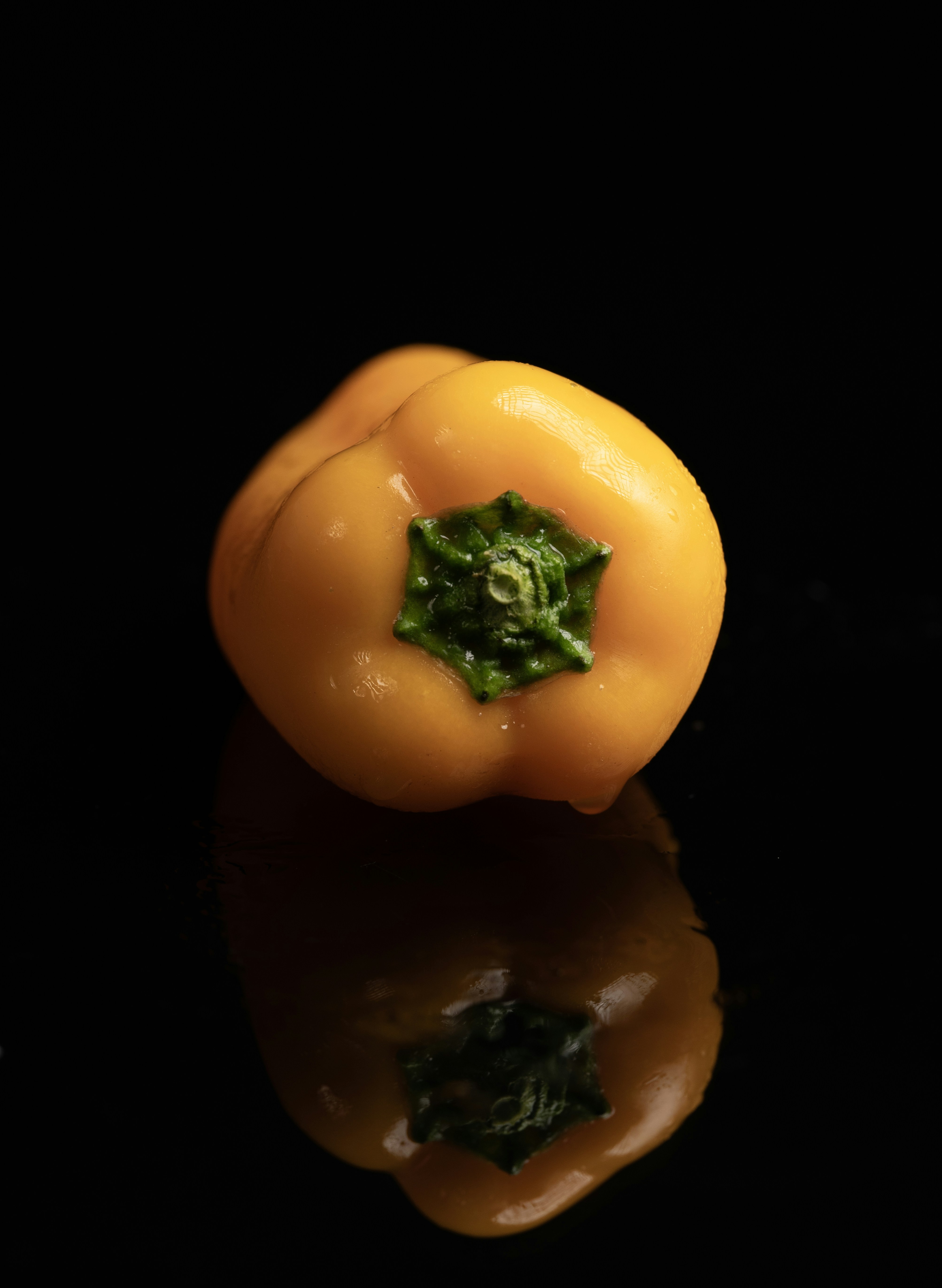 Golden Pepper Under Black Glass: A Glowing still life